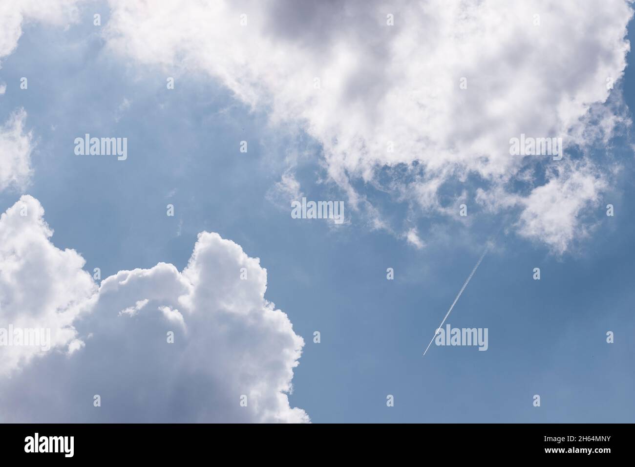 Airplane trails seen between clouds Stock Photo - Alamy