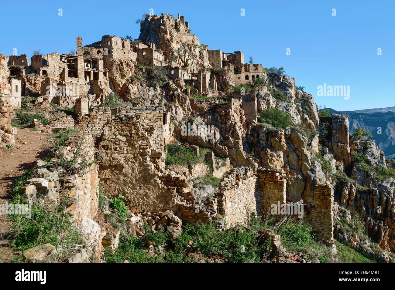 View of the abandoned ancient mountain village of Gamsutl on a sunny ...