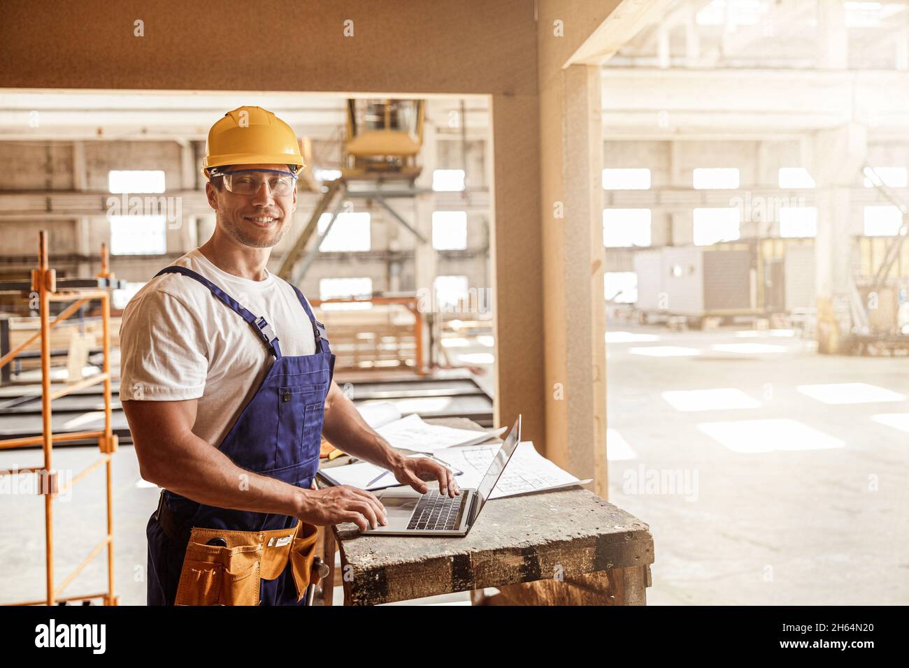 Architect using laptop at construction site hi-res stock photography ...