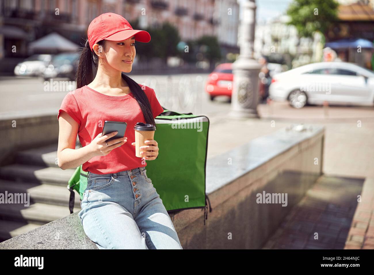 Woman courier worker enjoying free time outdoors Stock Photo - Alamy