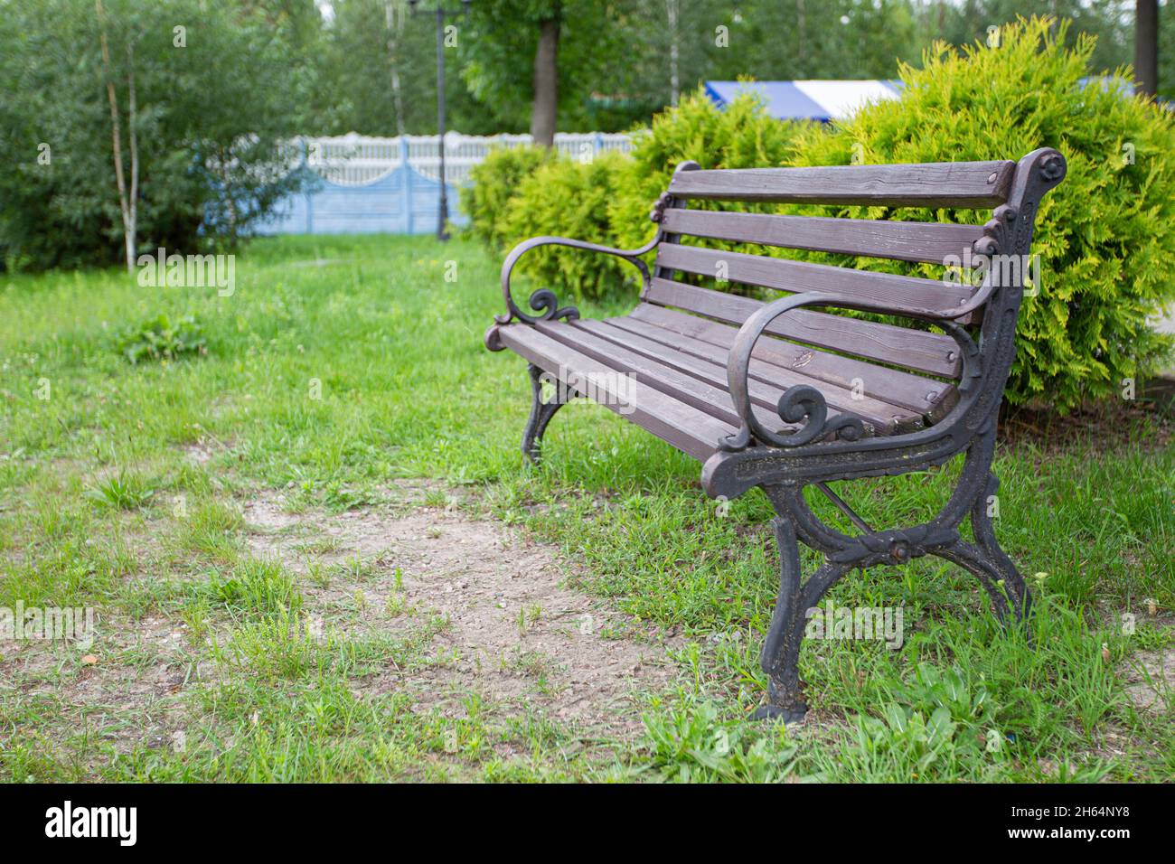 Wooden bench in a summer park Stock Photo - Alamy