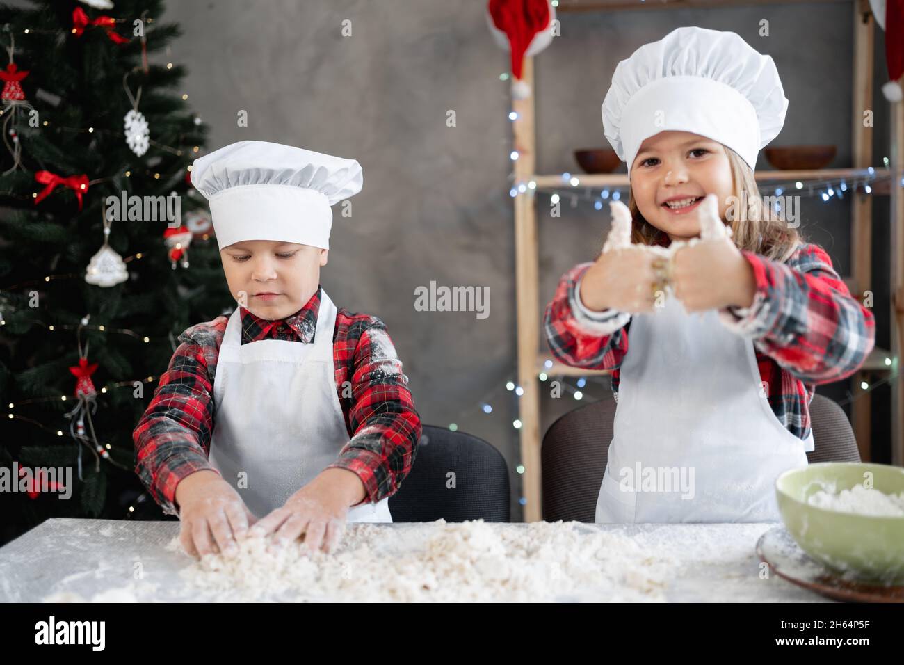 Happy family, children prepare dough, bake gingerbread in the kitchen ...