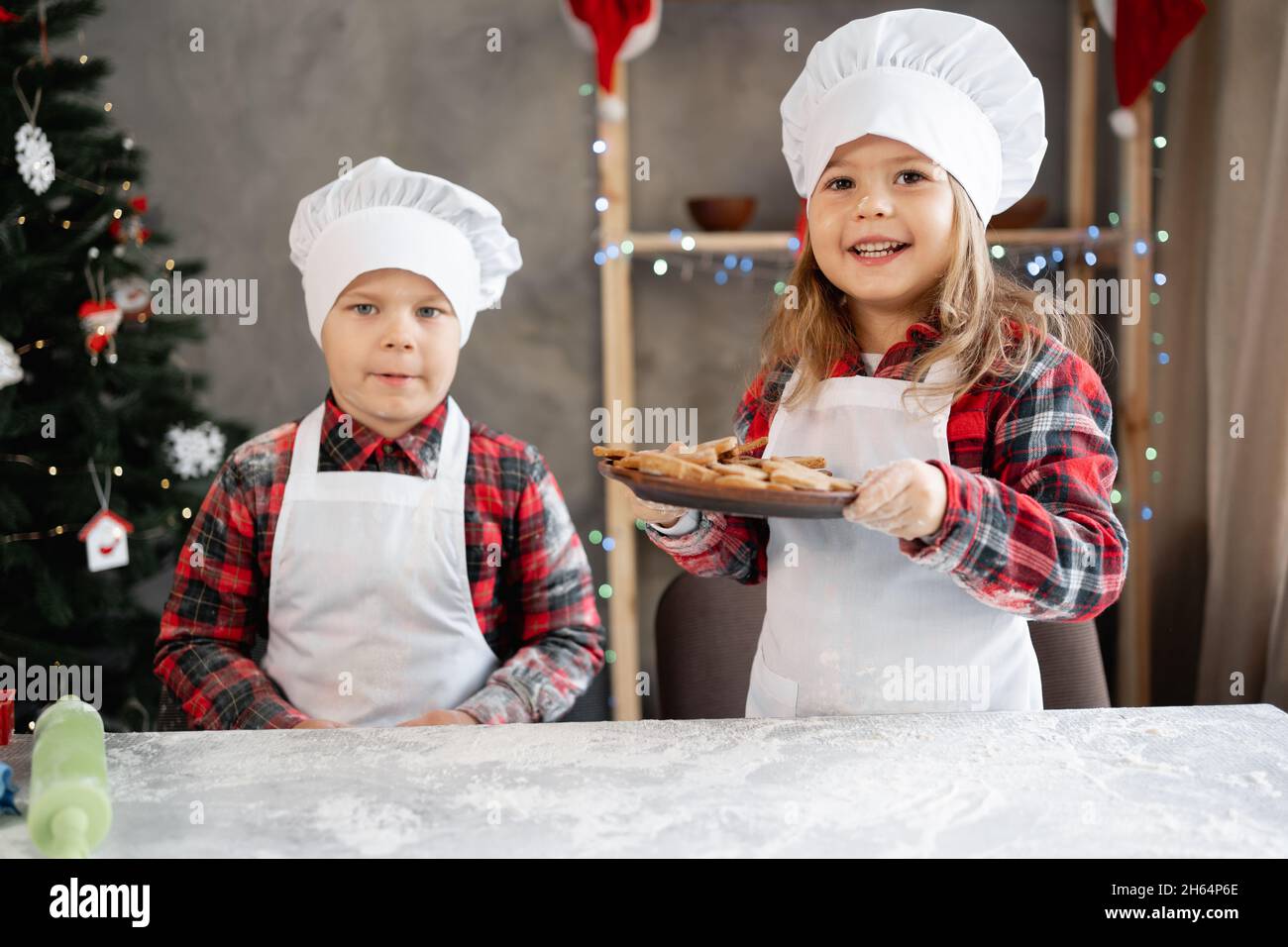 Children baking Christmas cookies before the holiday in the home ...