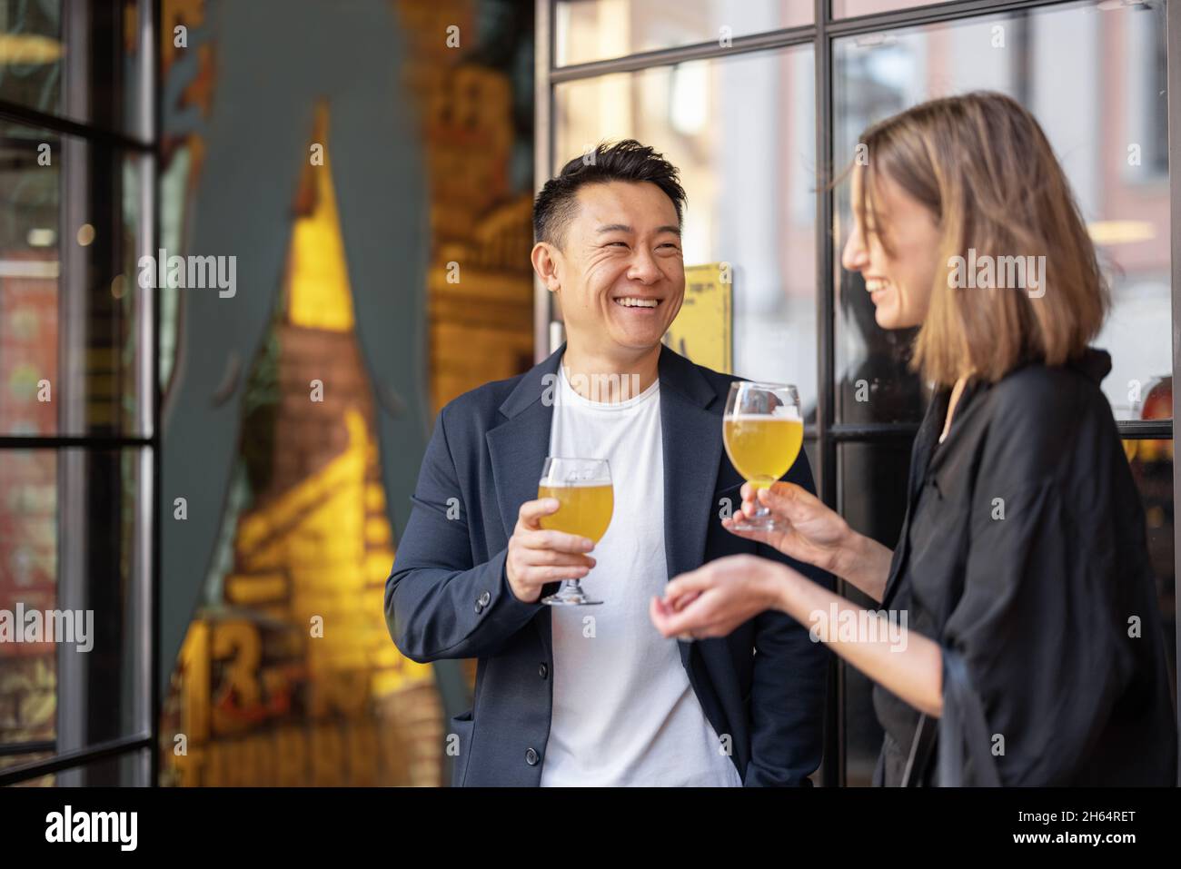 Woman and man drinking cocktails at cafe Stock Photo - Alamy