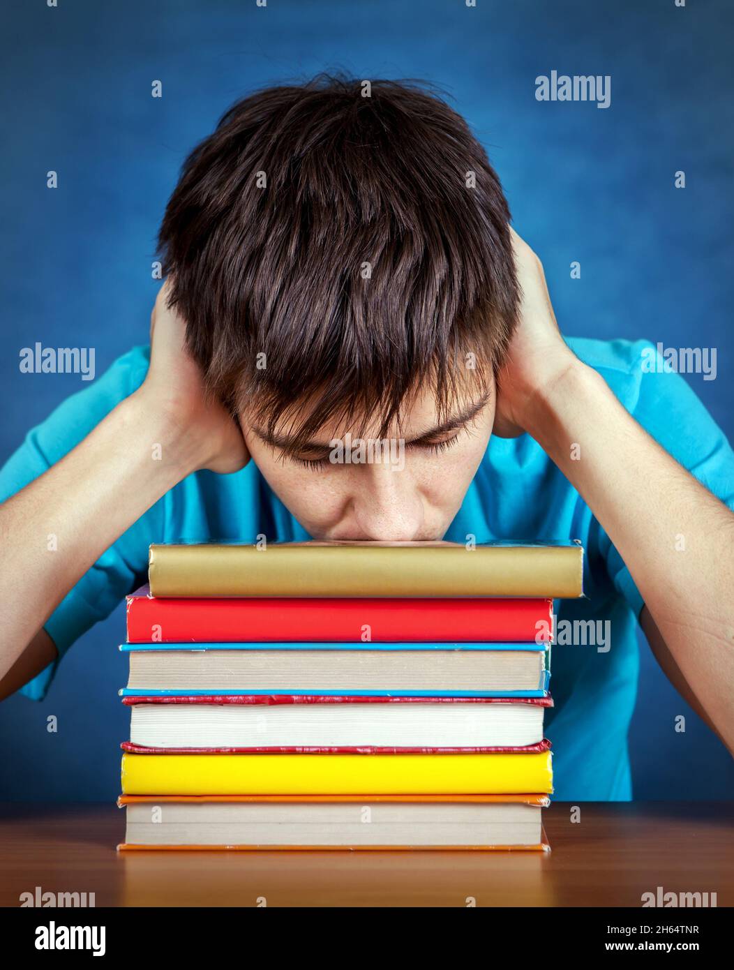 Sad and Tired Student with the Book on the Blue Background Stock Photo ...
