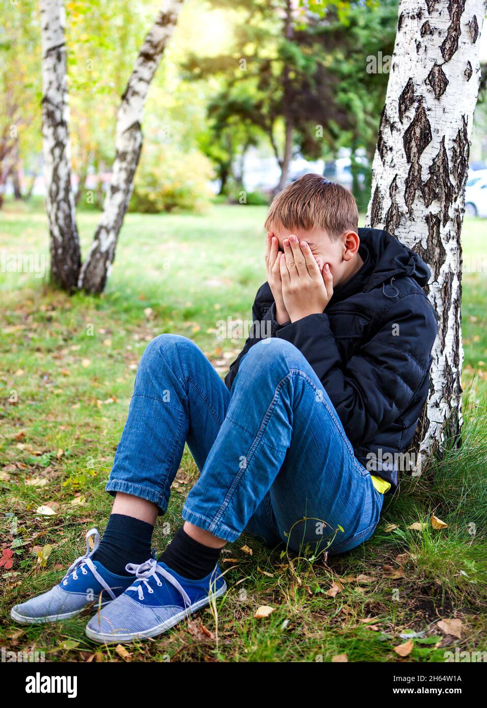 Sad Teenager sit under Tree in the Park Stock Photo - Alamy