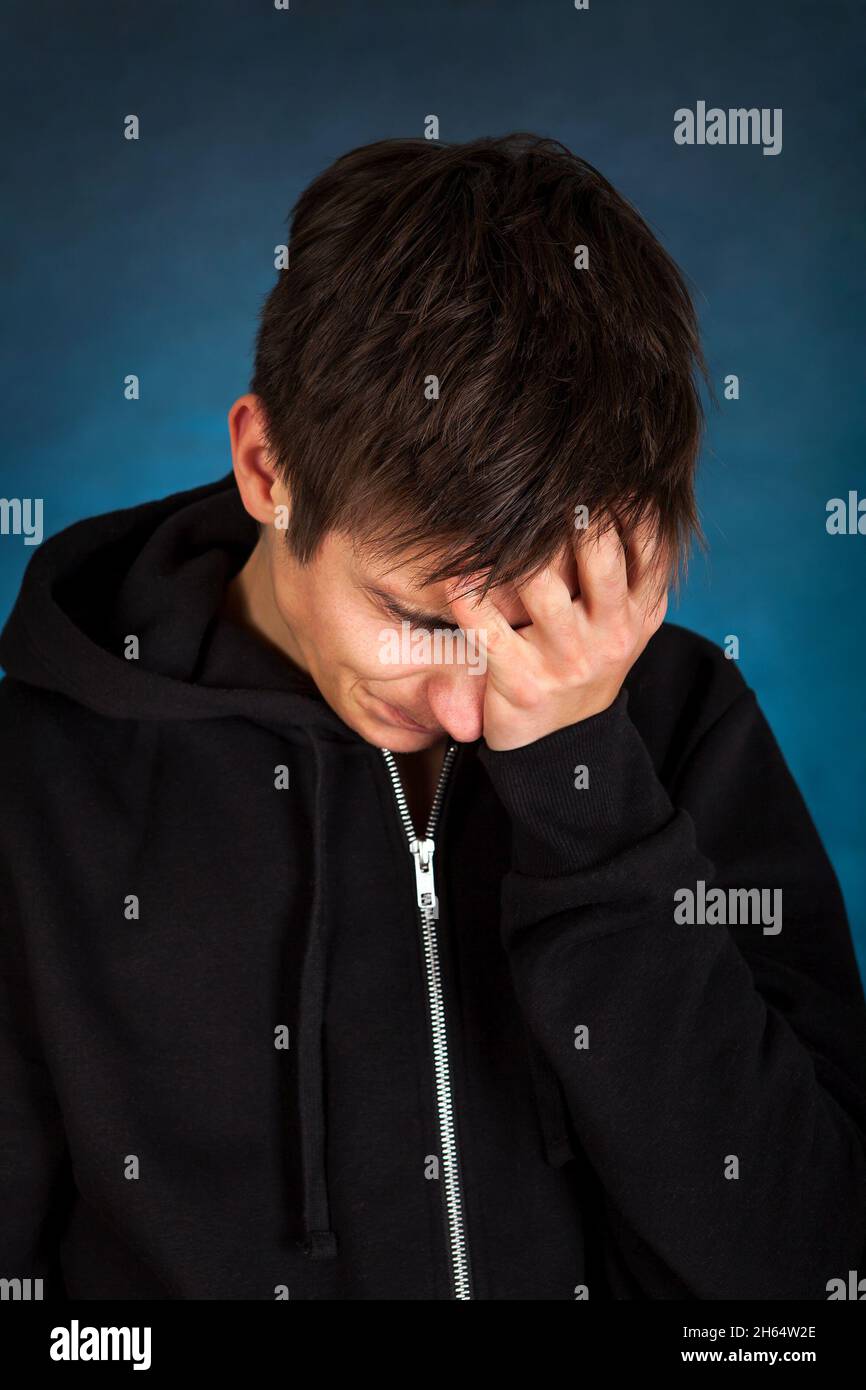 Sad Young Man on the Dark Background Stock Photo - Alamy