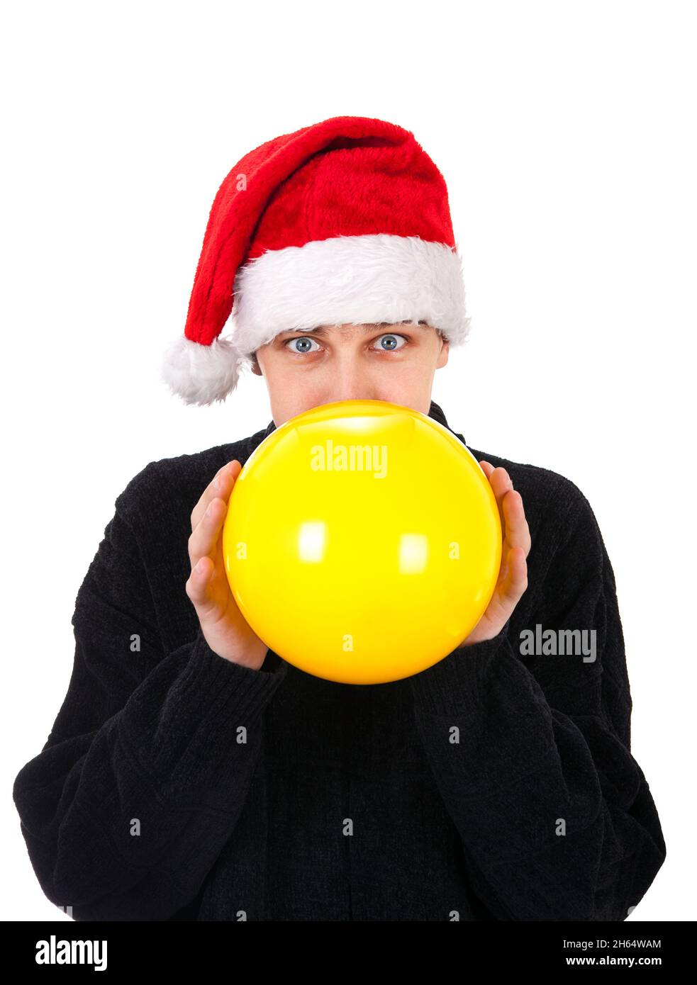 Young Man in Santa Hat inflate a Yellow Balloon Isolated on the White ...