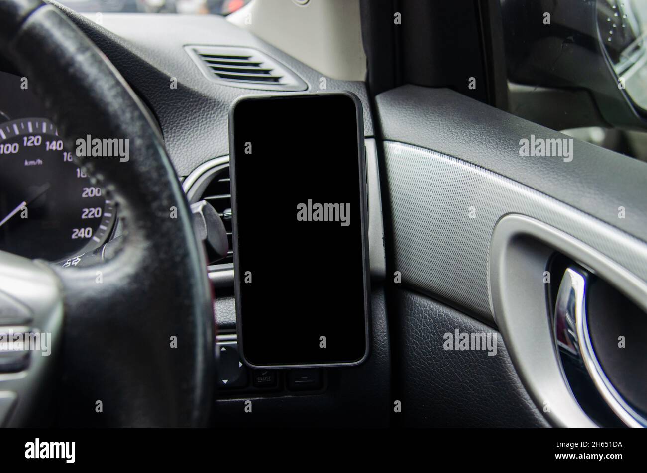 Mobile phone on the car air vent.Blank with white screen.Mock up smart ...