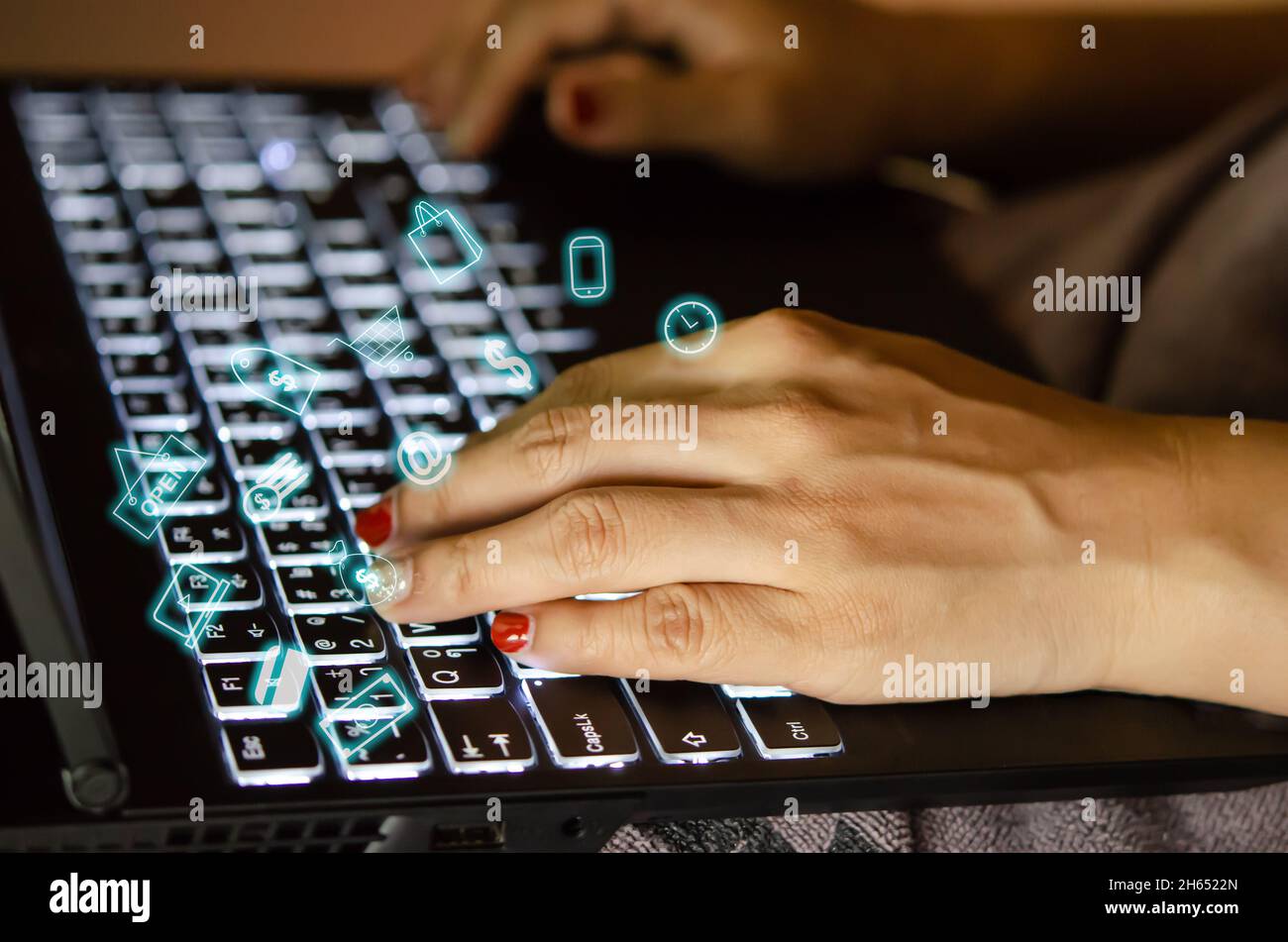 female hands using keyboard computer laptop with flying shopping online icons Stock Photo - Alamy