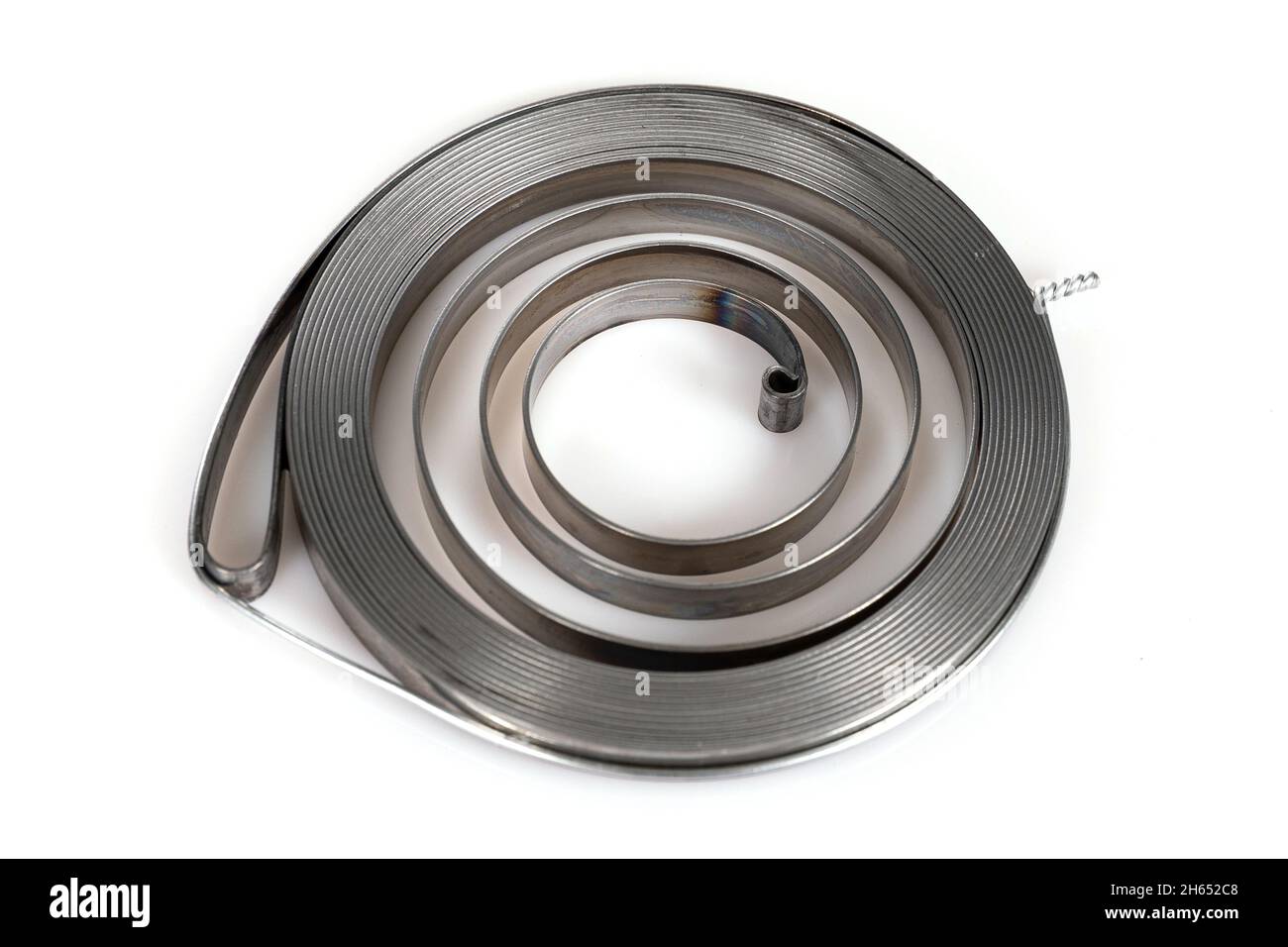 recoil spring for starter on white background Stock Photo - Alamy
