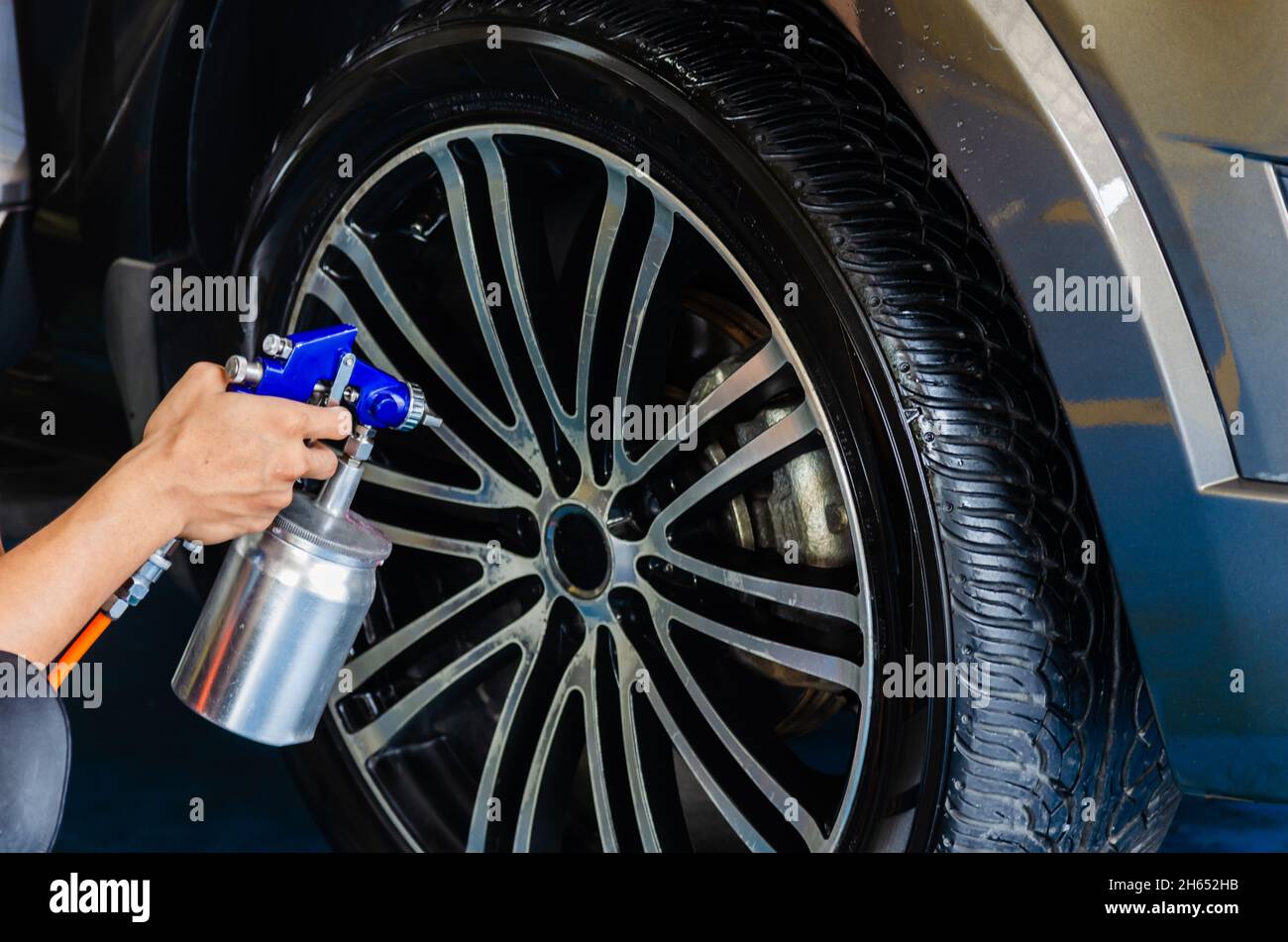 Car wash service. Use liquid spray coating wheel outside the wax Stock ...