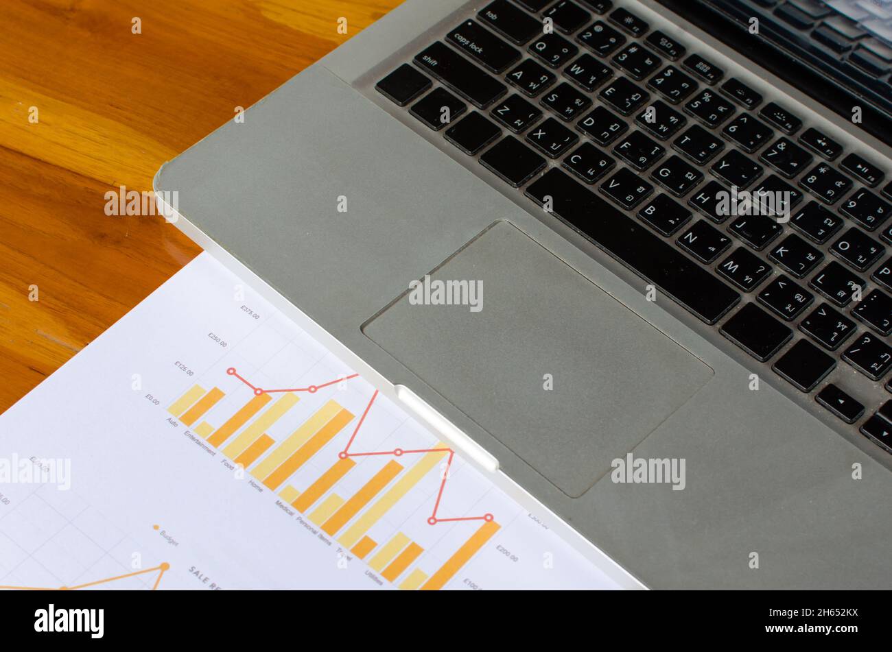 Workplace, analysis of graphics with laptop Stock Photo - Alamy