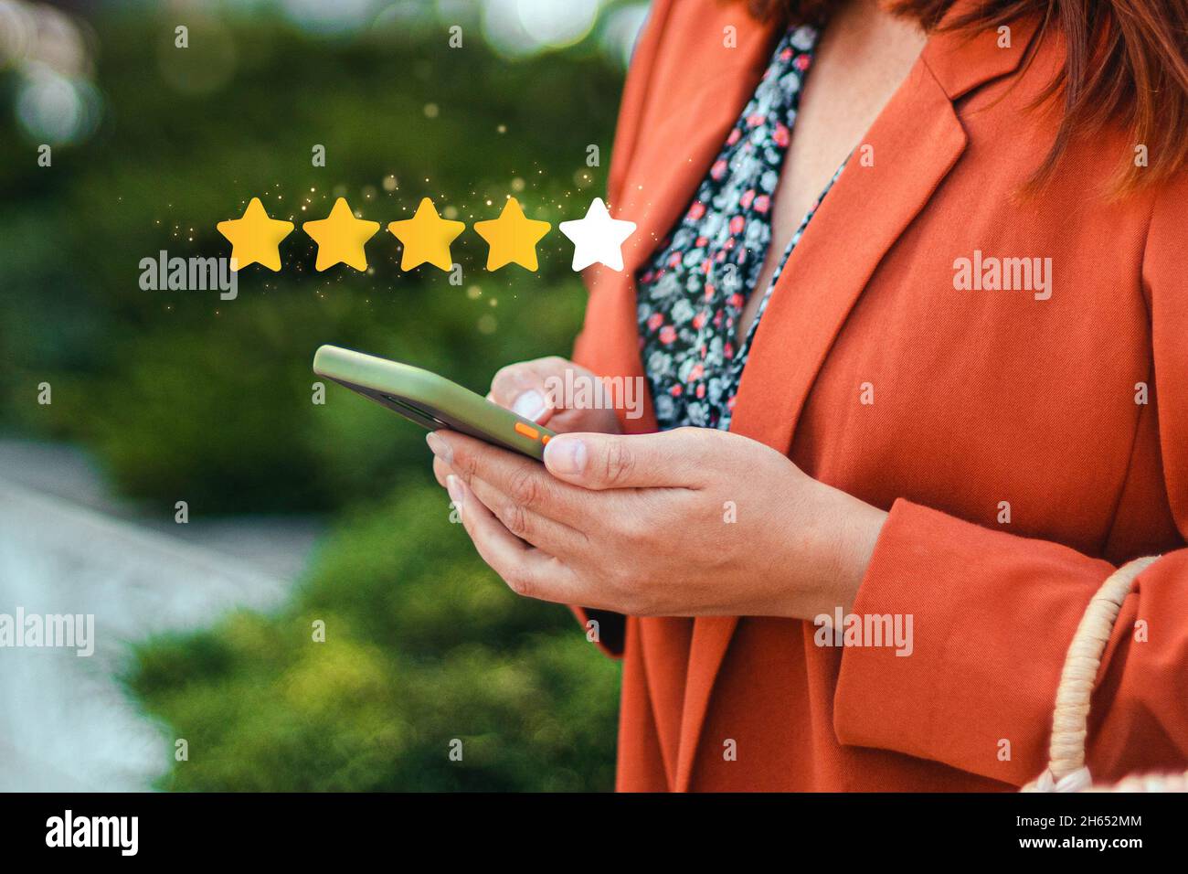 Excellent. Person using mobile phone with icon 4 star symbol to ...