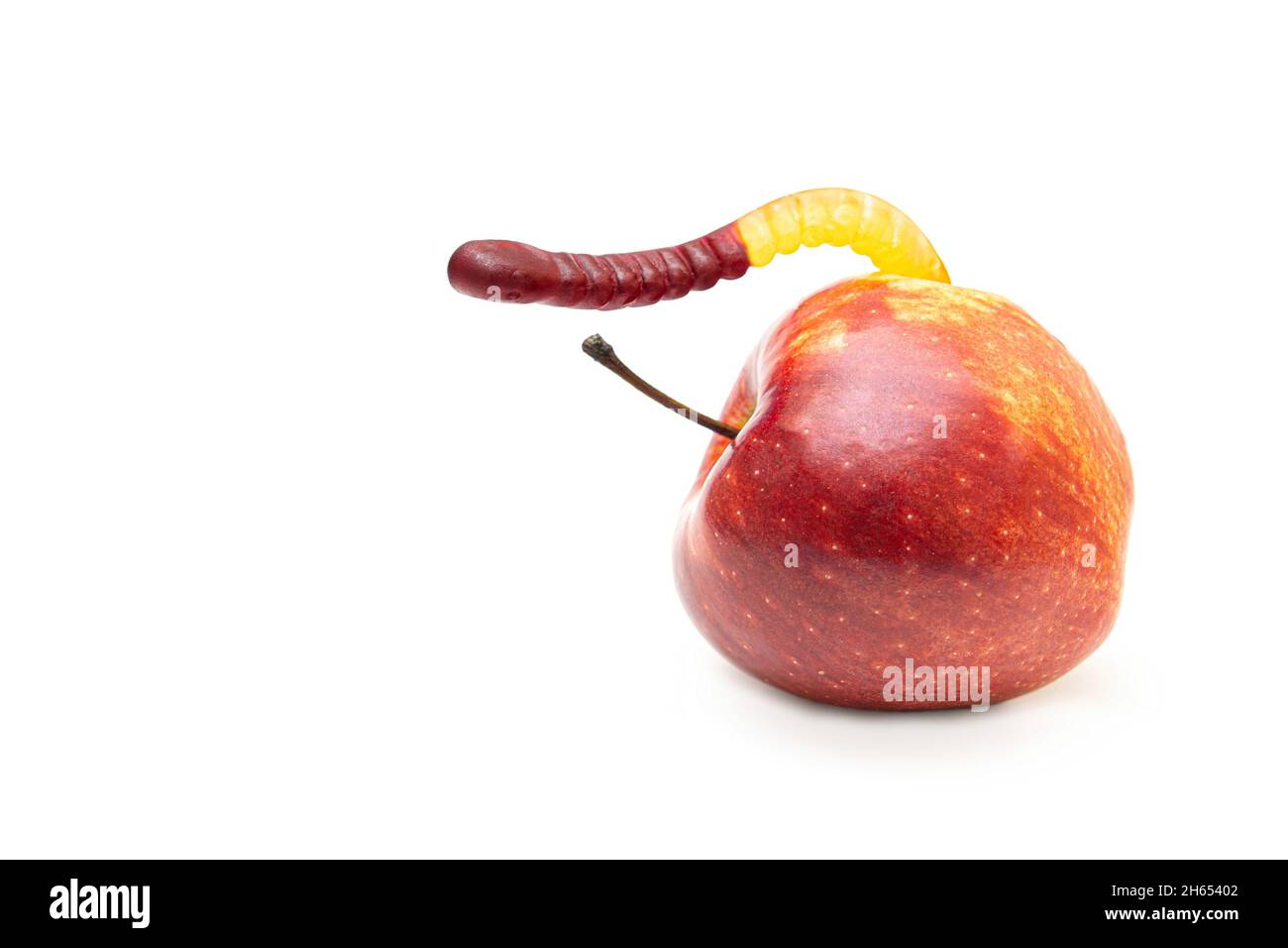 Red apple with a candy worm isolated on white Stock Photo - Alamy