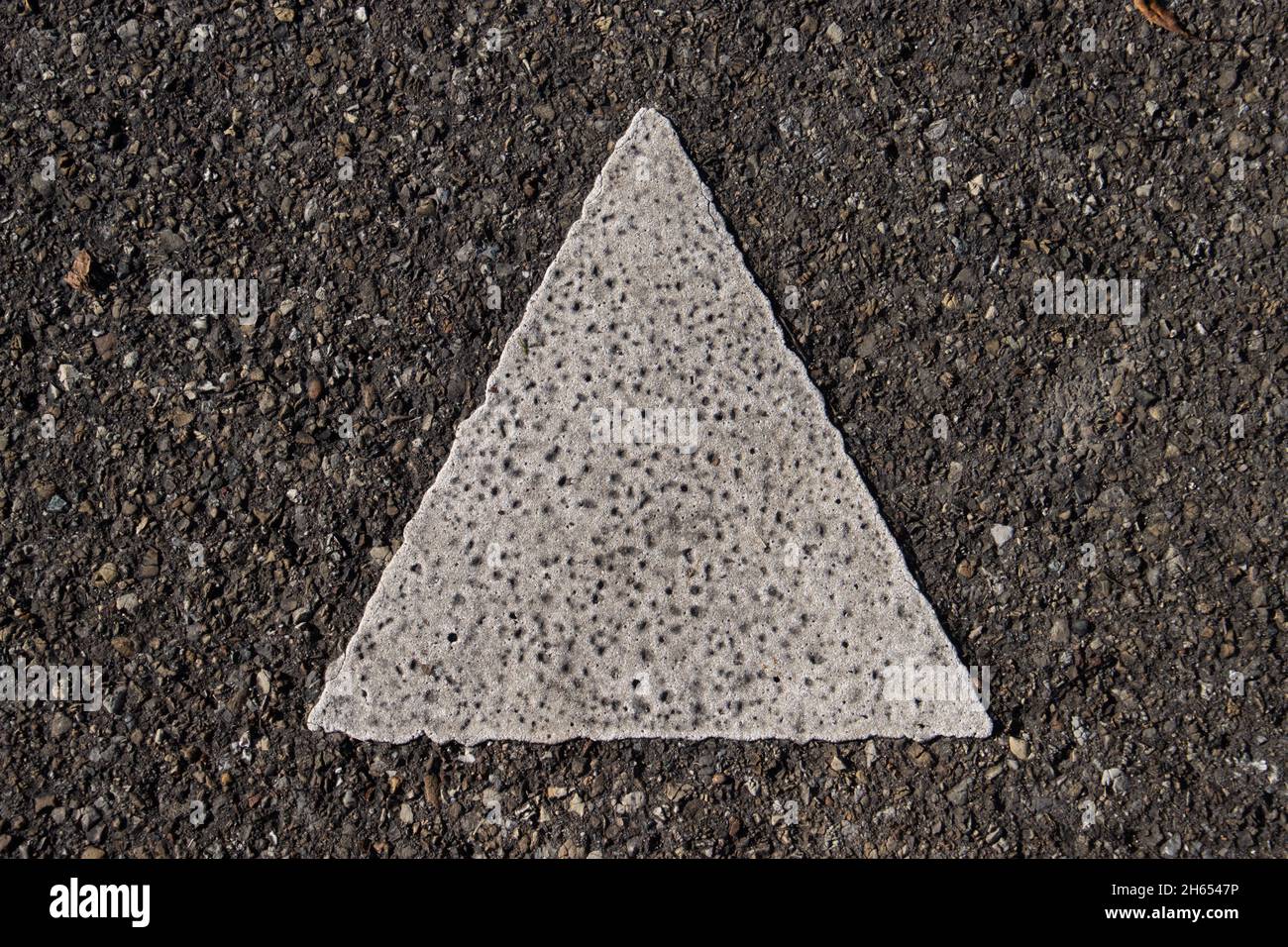 Close up of a isosceles triangle painted with thick white paint on the ...