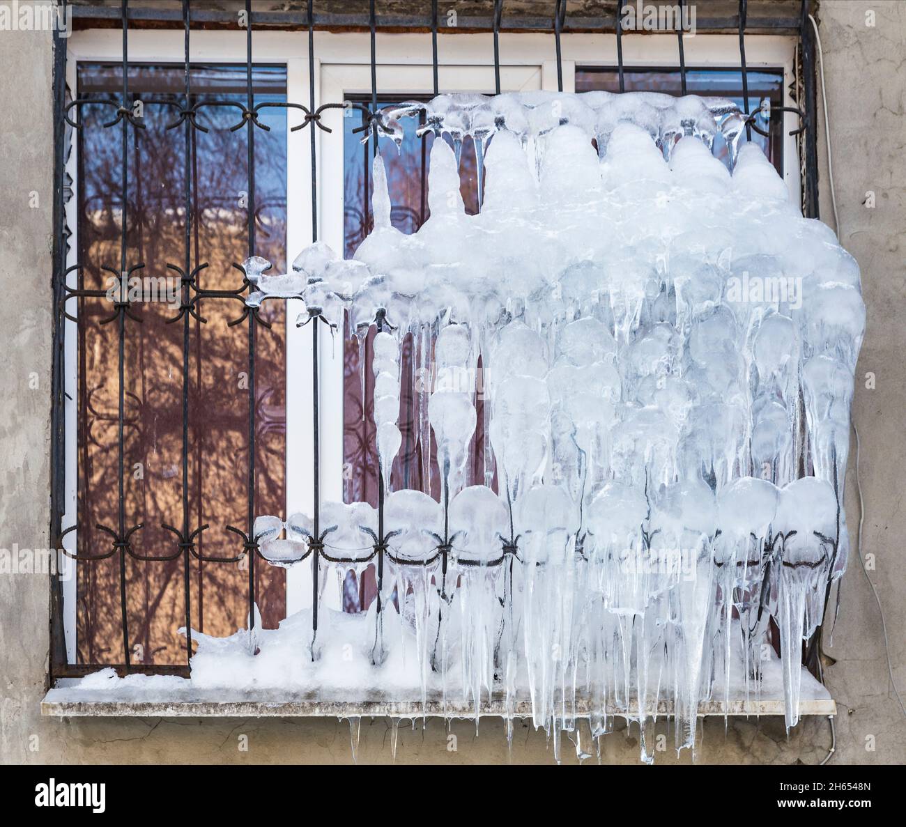 Bizarre ice a?? iclicles on the window grid in winter. Dangerous large ...