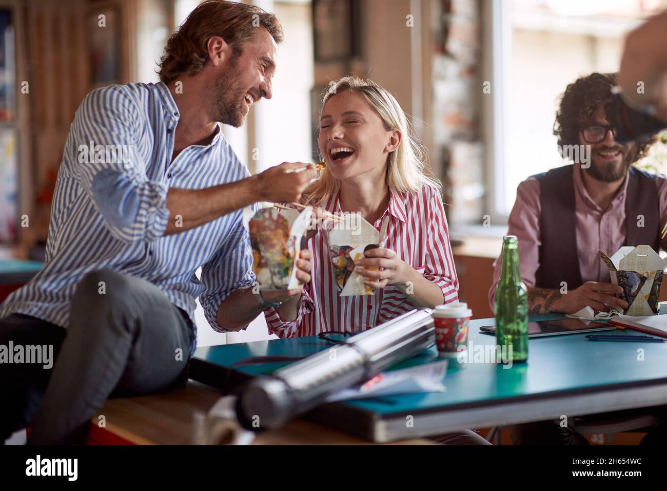 Employees are having fun during a lunch break in a relaxed atmosphere ...