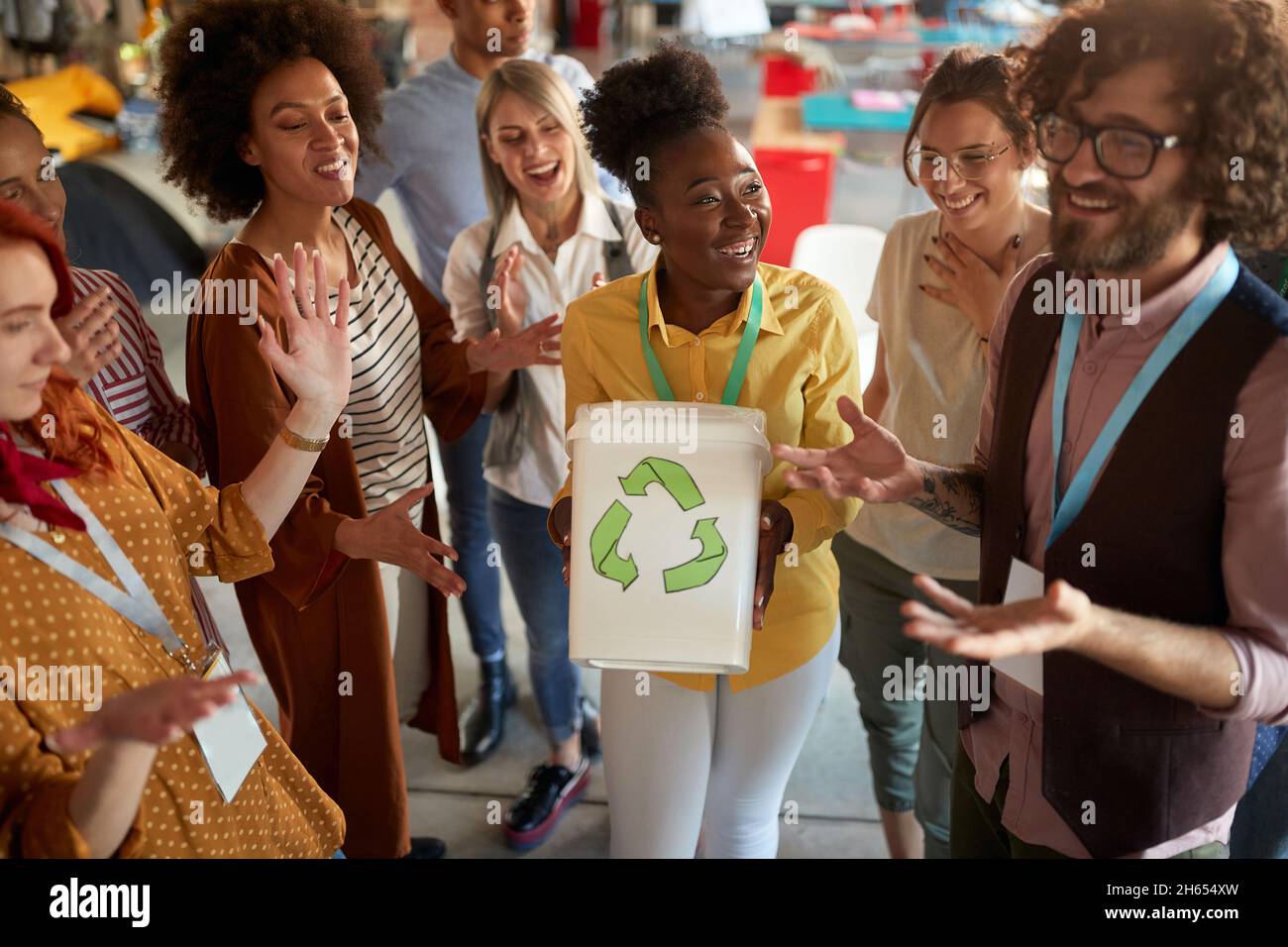 Group of young employees recycling in the office Stock Photo - Alamy