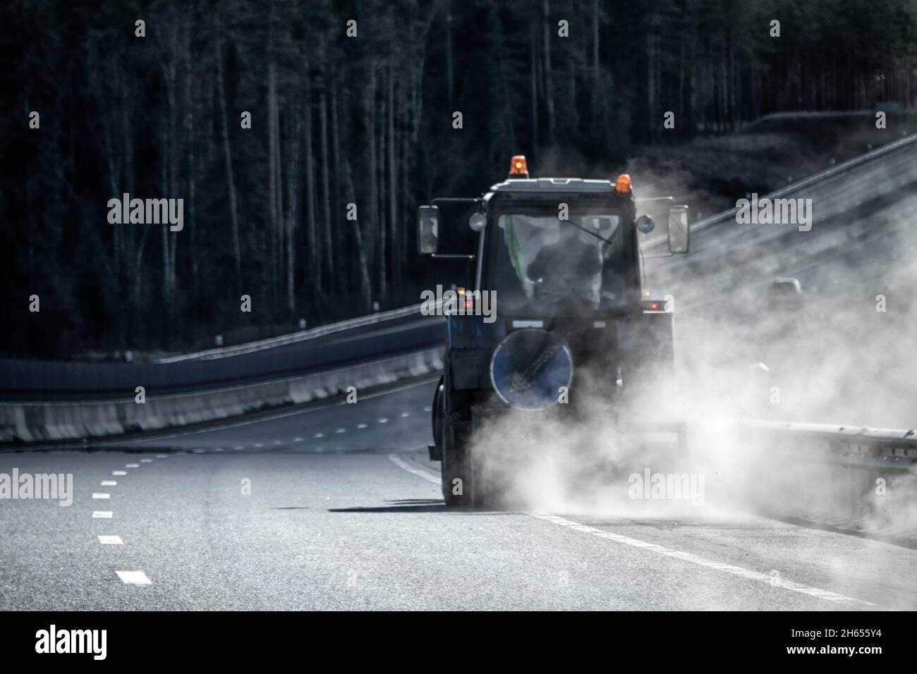 Sweeping the freeway after winter, road service. A special tractor ...