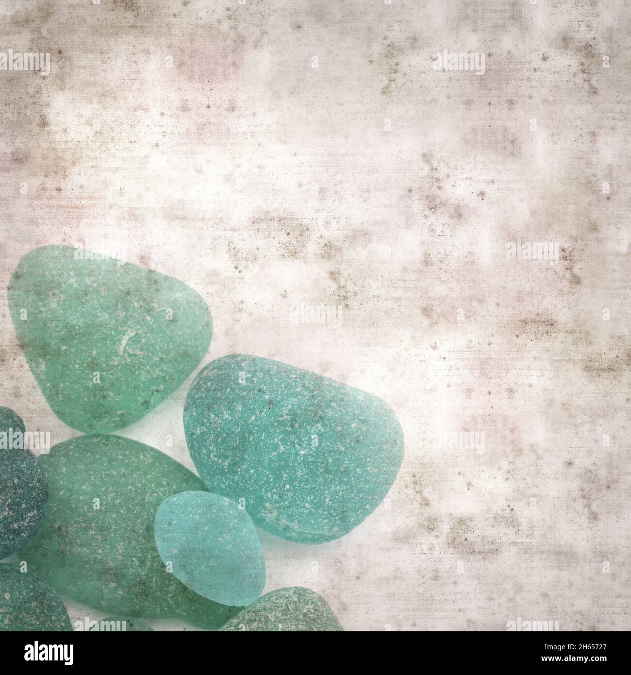 stylish textured old paper background with sea glass pebble pieces ...