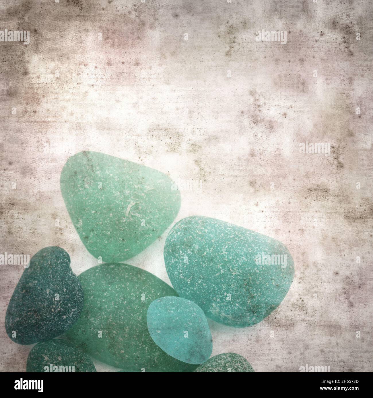 stylish textured old paper background with sea glass pebble pieces ...