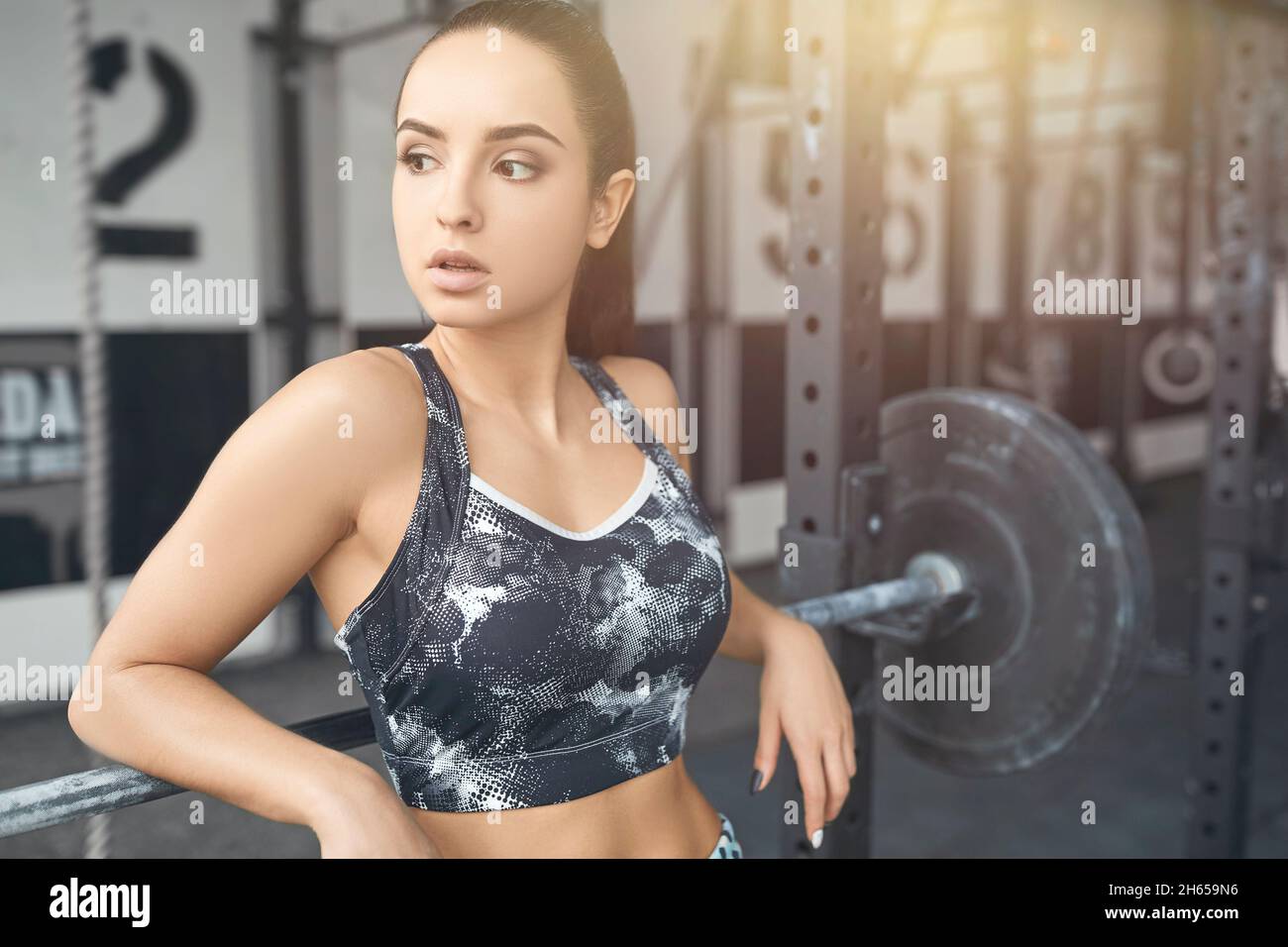 Young woman exercises in gym healthy lifestyle pulling weights Stock ...