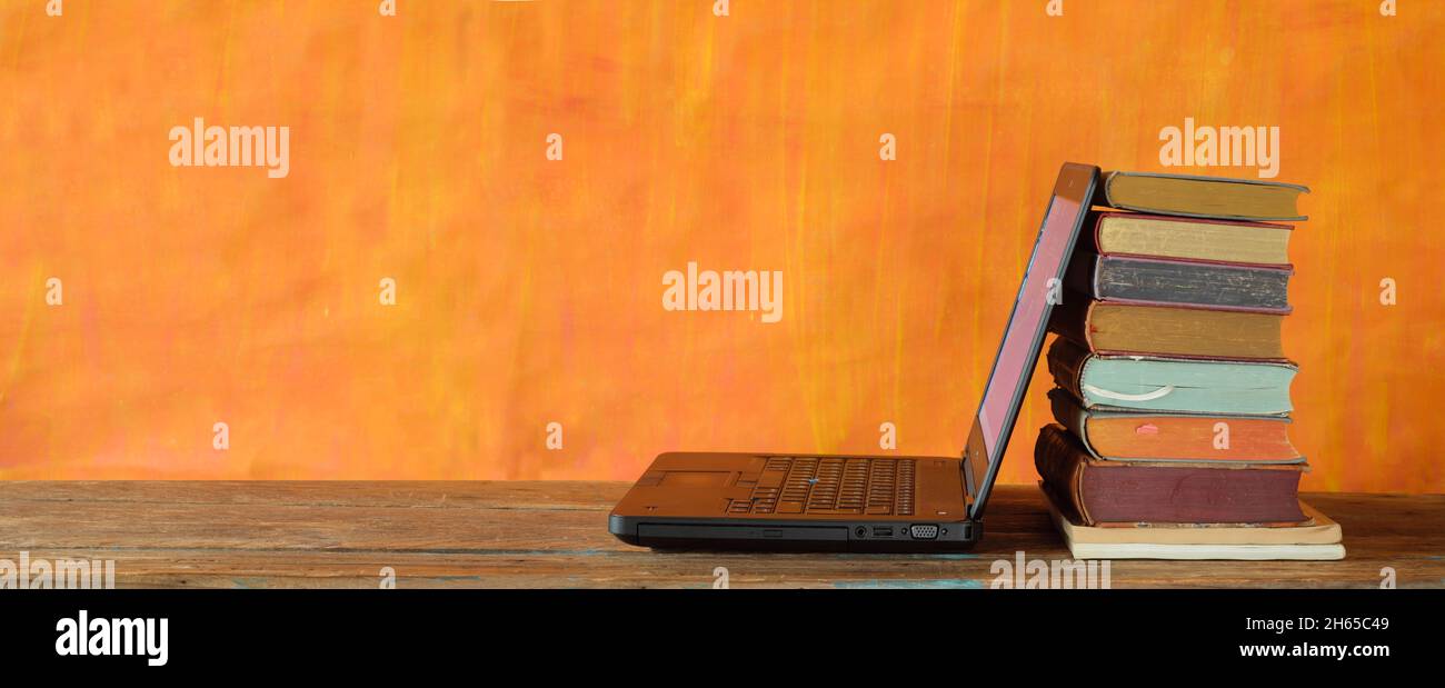 Stack of books and laptop computer ,home office, homeschooling,reading ...