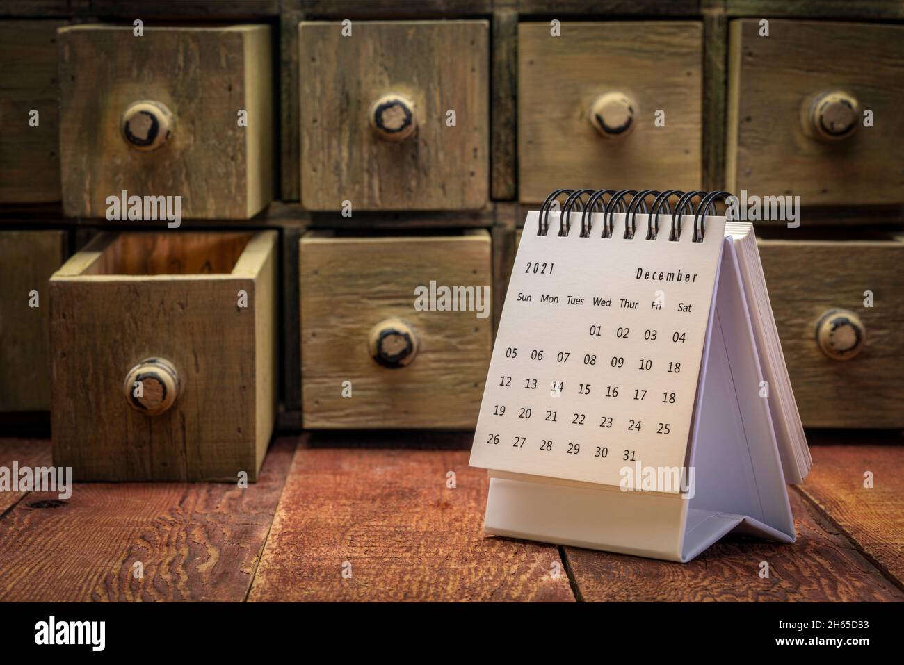 December 2021 - spiral desktop calendar on a weathered barn wood table ...