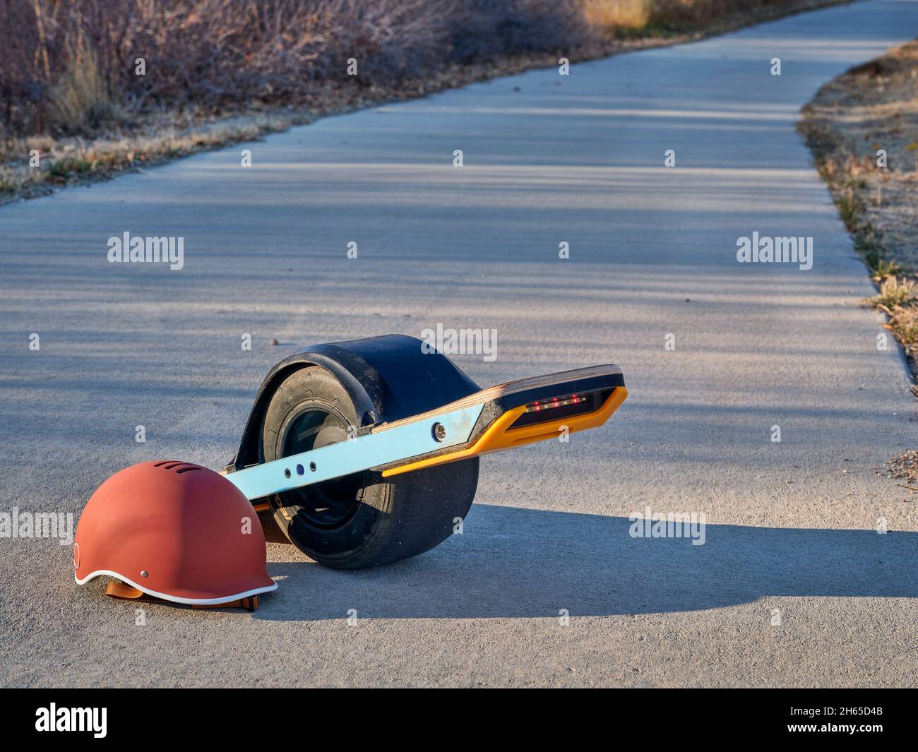One-wheeled electric skateboard (personal transporter) with a helmet on ...
