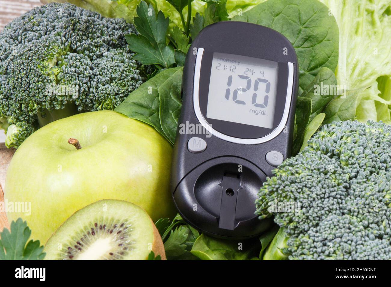 Glucose meter and fresh ripe green fruits with vegetables as healthy ...