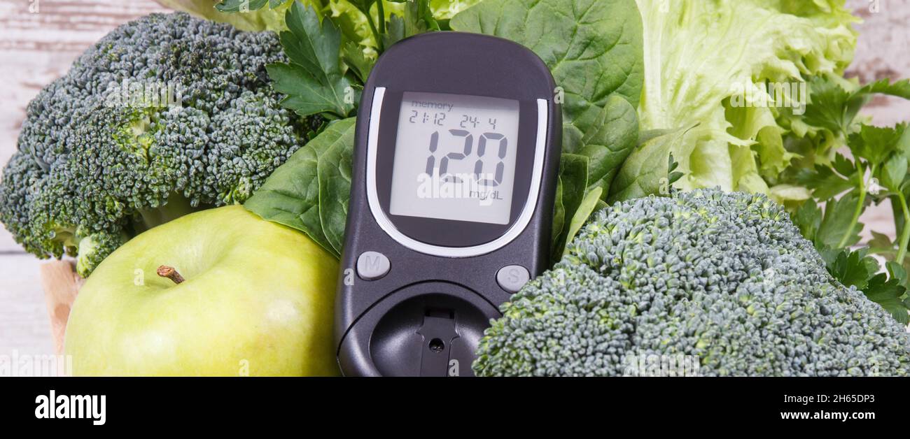 Glucose meter and fresh ripe green fruits with vegetables as healthy ...