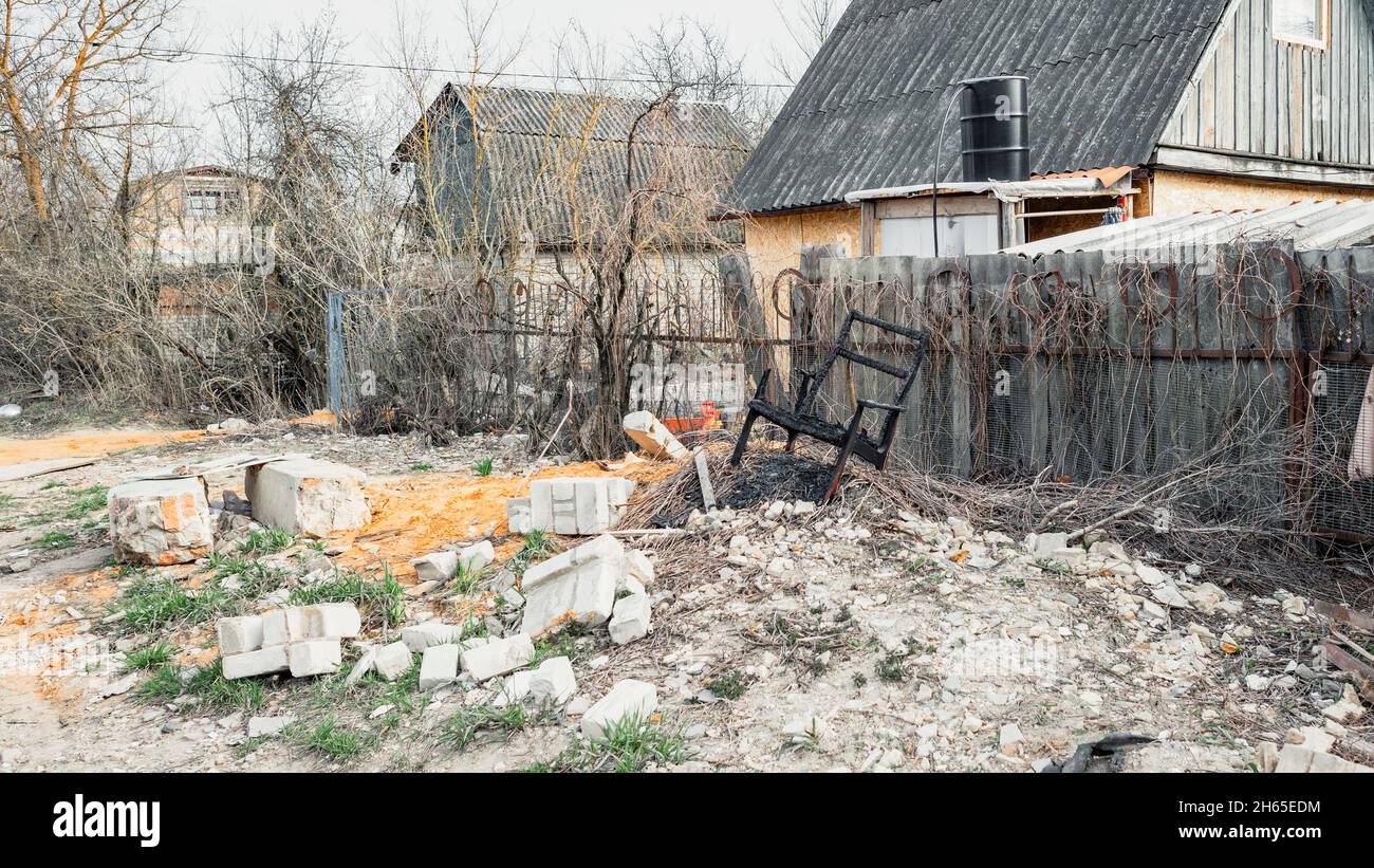 Burnt chair, similar to the throne, standing on a pile of construction ...