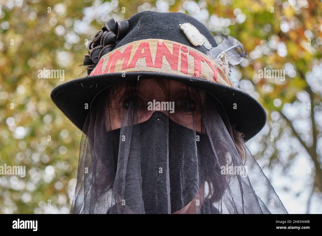 London, UK. 13th Nov, 2021. A woman wears a hat saying 'Code Red for ...