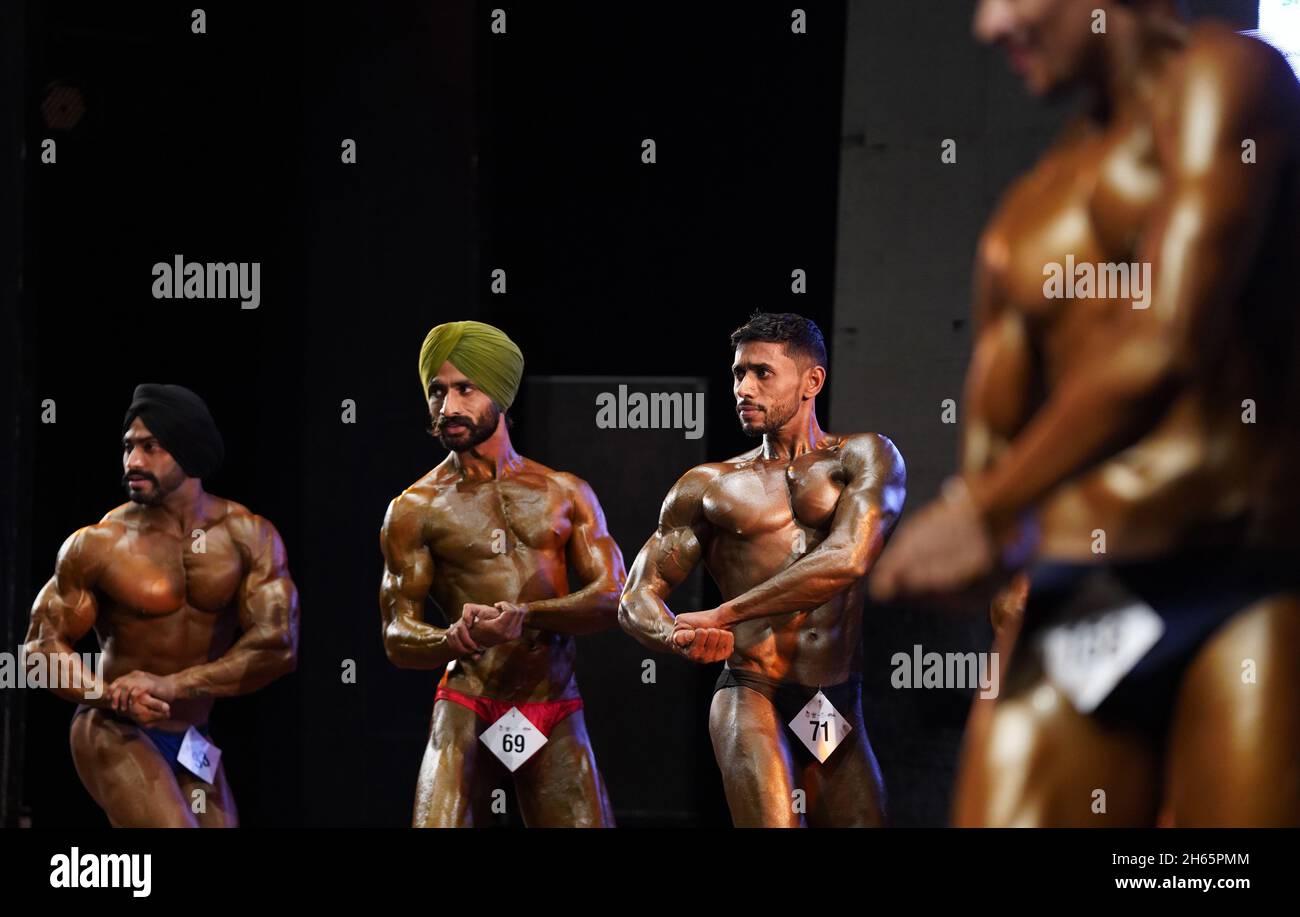 bodybuilders showing their muscles during the NPC North India Body ...