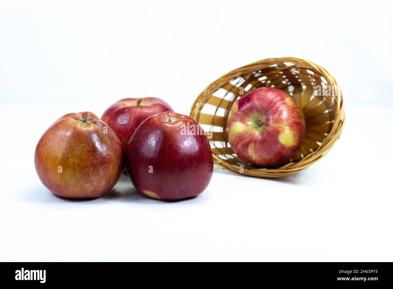 red apples in a basket on a white background Stock Photo - Alamy