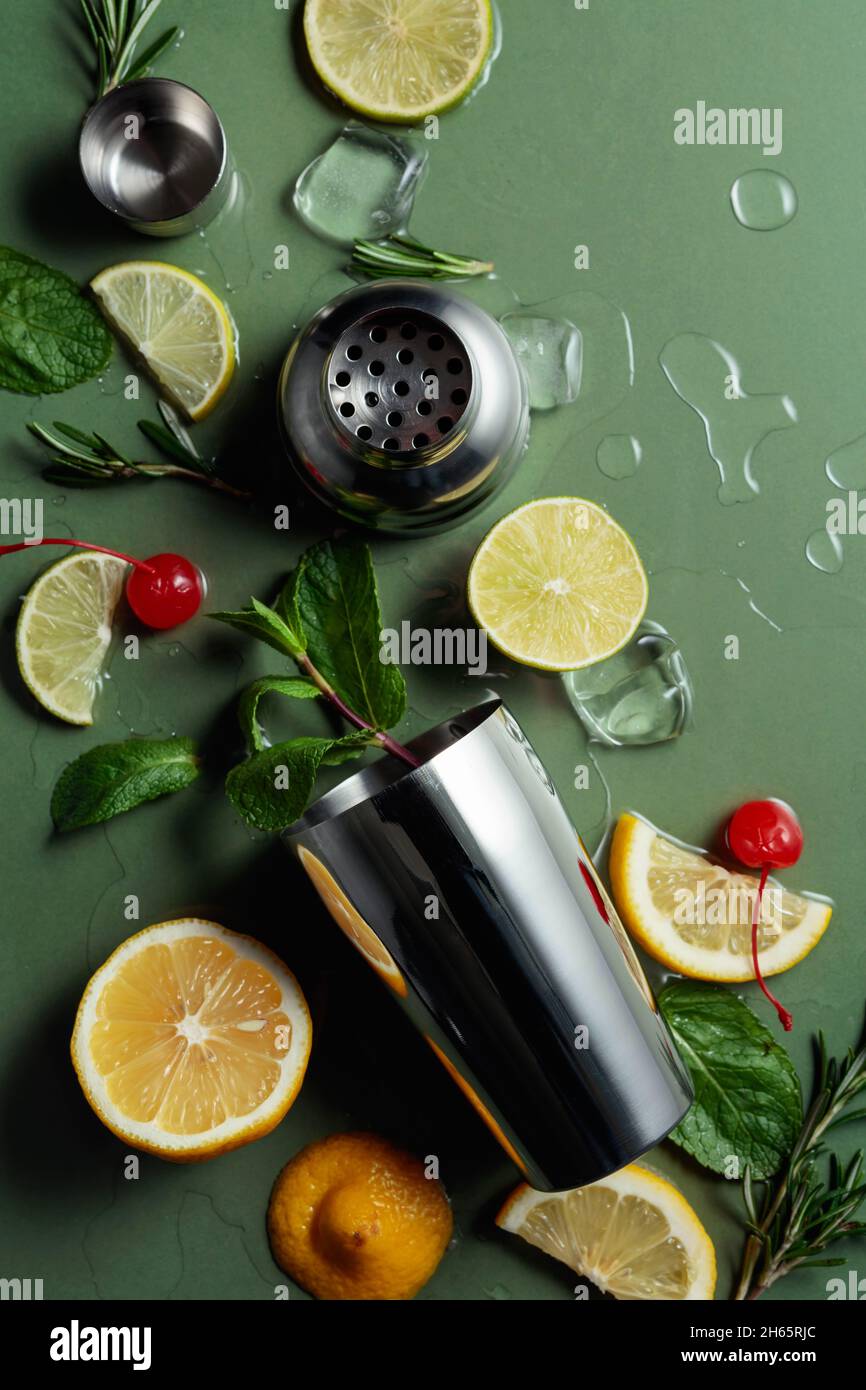 Shaker with ingredients for making cocktails. Green background. Top ...