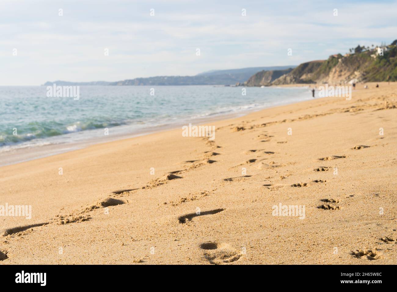 Footprints on the sand at empty beach on sunny day in Algarrobo, Chile ...