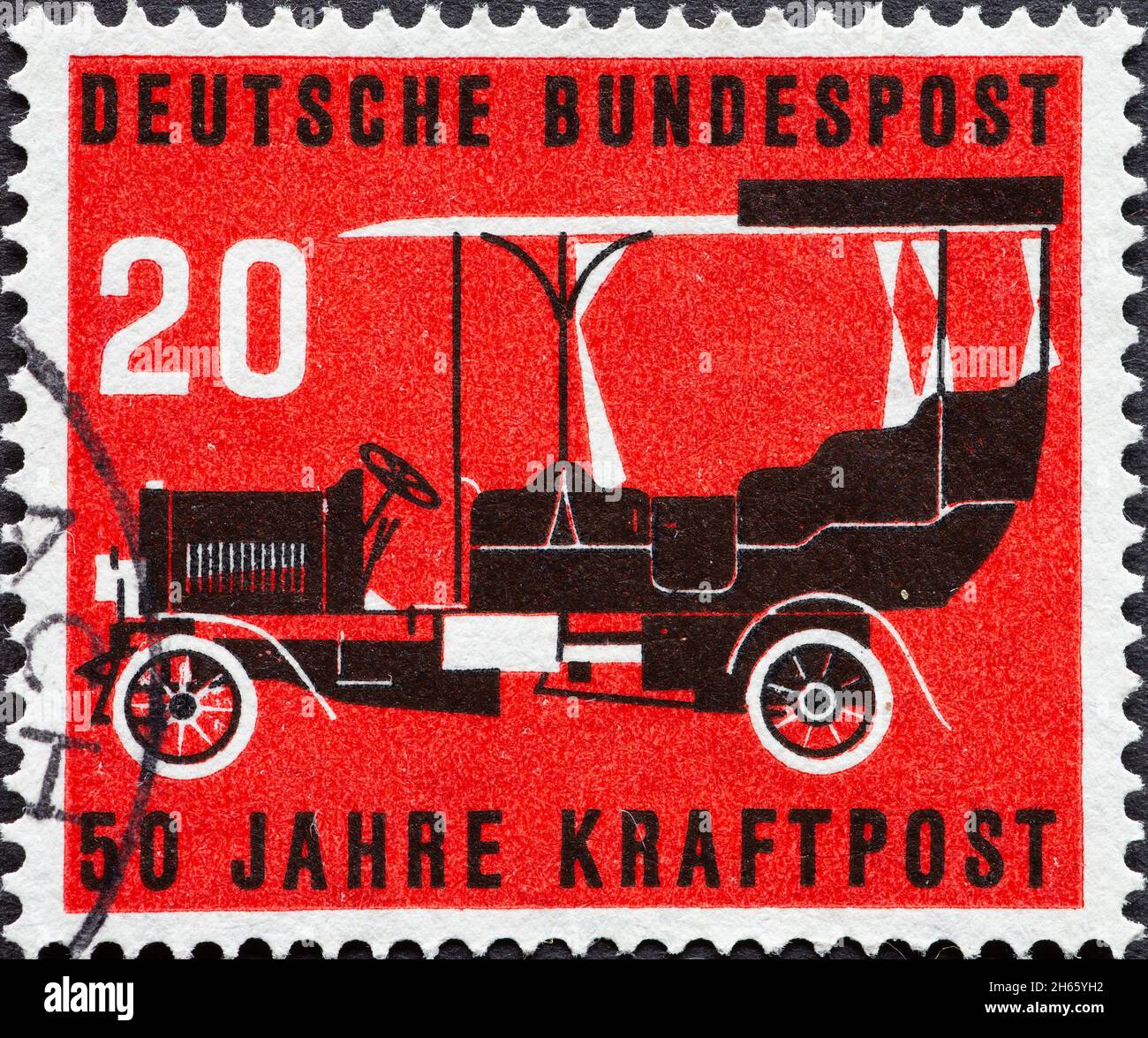 GERMANY - CIRCA 1955: This postage stamp shows shows a post bus from ...