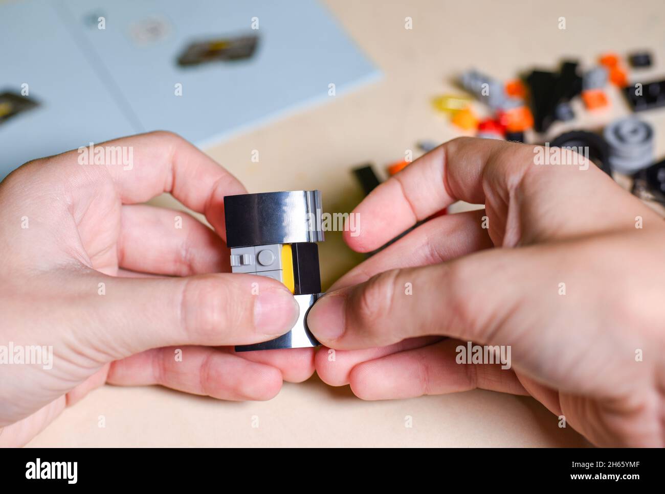 The hands of a teenager assemble a constructor from parts Stock Photo ...
