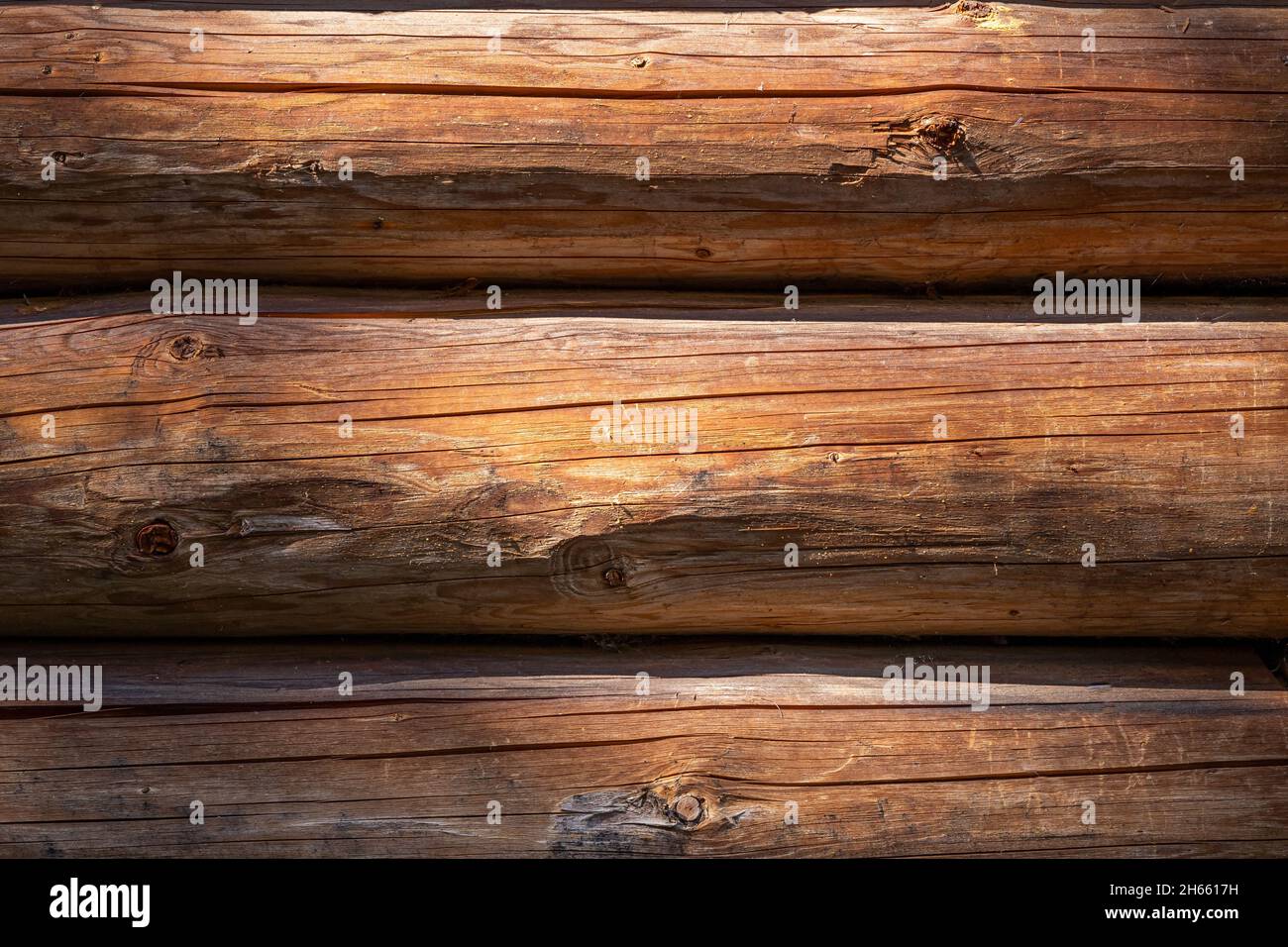 An old cottage wall, made of wooden logs. A background with copyspace ...