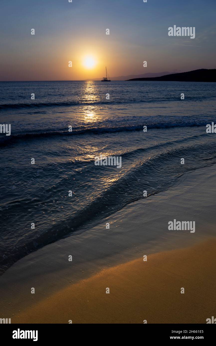 Yacht riding an anchor during sunset off Paros beach, Paros Greek ...