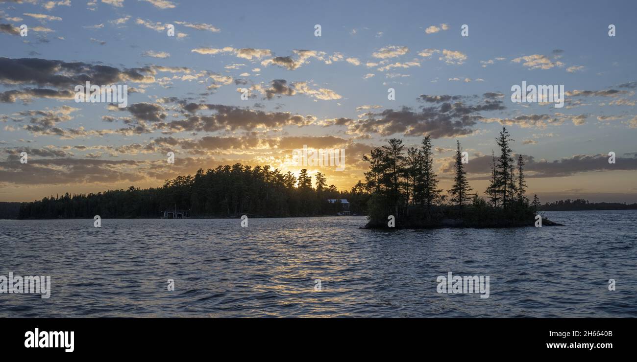 Beautiful view of a lake, pine trees on the sunset sky background Stock Photo - Alamy