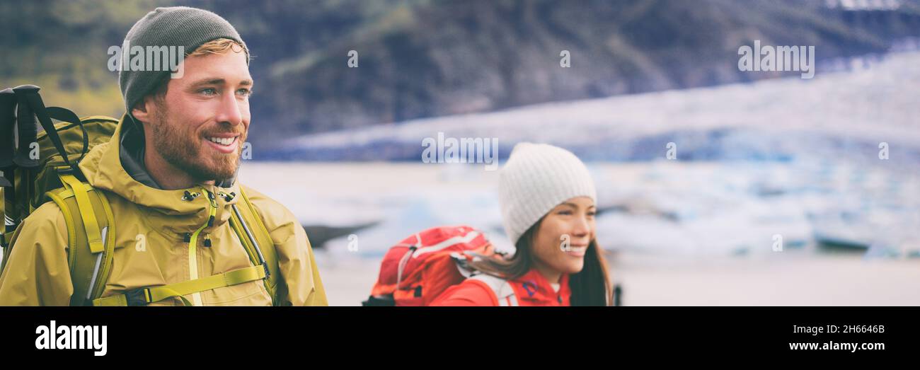 Two hikers people walking together hiking in wilderness. Alpine ...