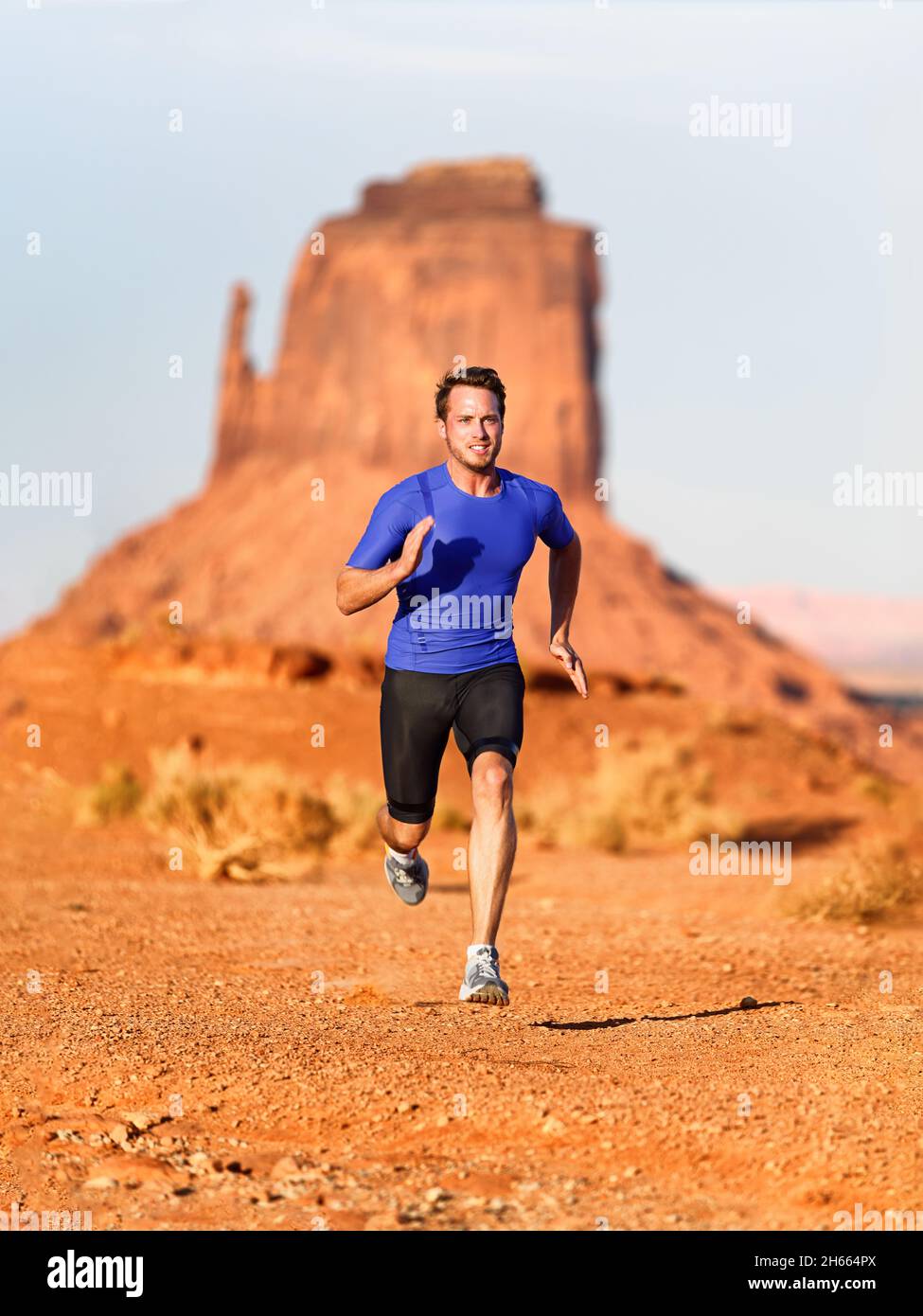 Runner. Running man sprinting in Monument Valley. Athlete runner cross ...