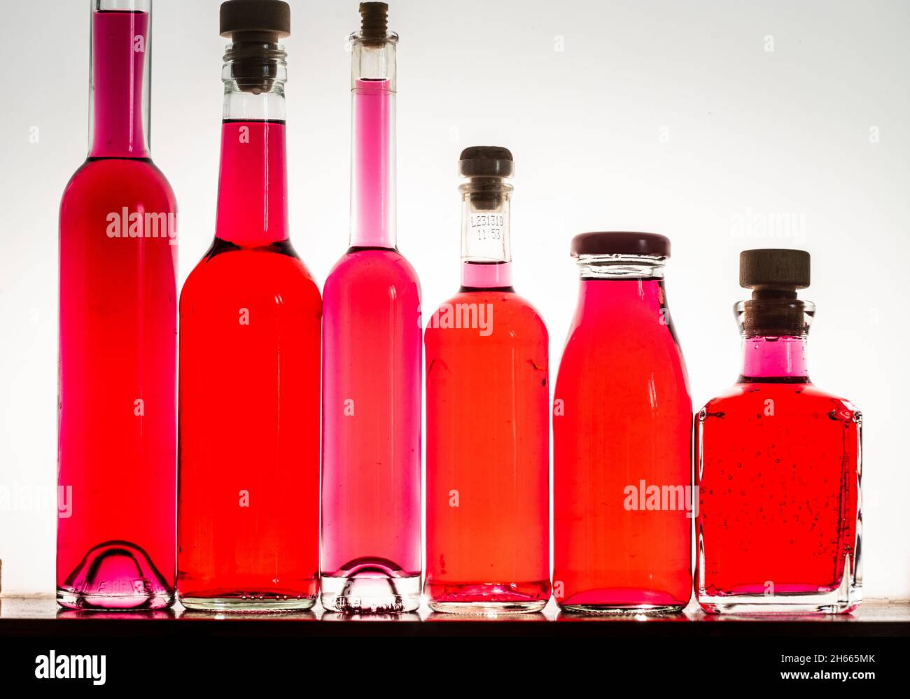 fruit liquid in transparent bottles Stock Photo - Alamy