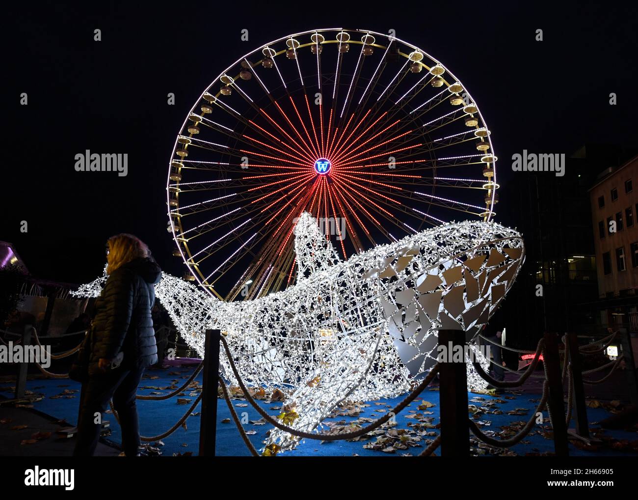 Essen, Germany. 13th Nov, 2021. An illuminated whale and a Ferris wheel ...