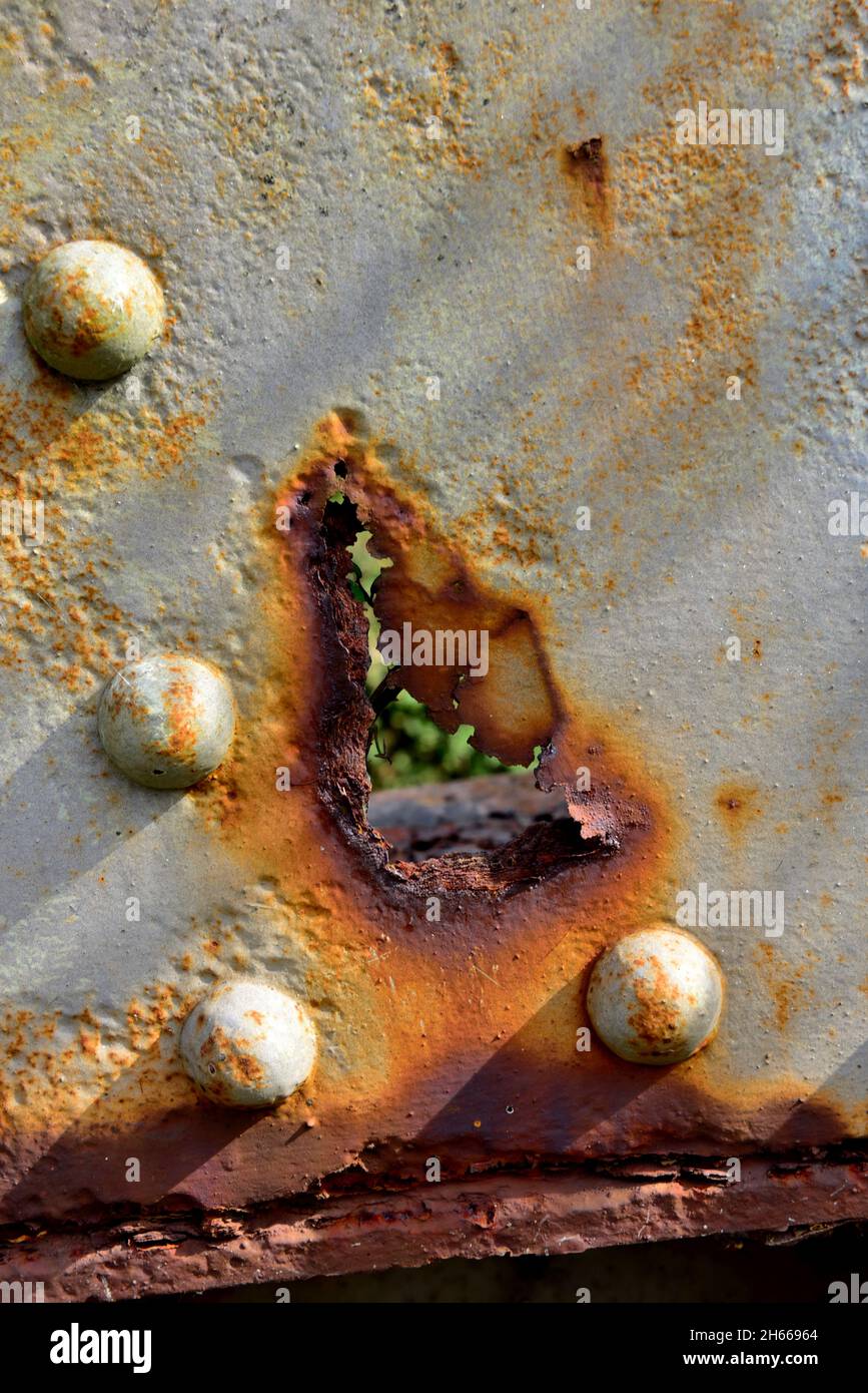 Abstract of colourful riveted rusty steel with hole Stock Photo - Alamy