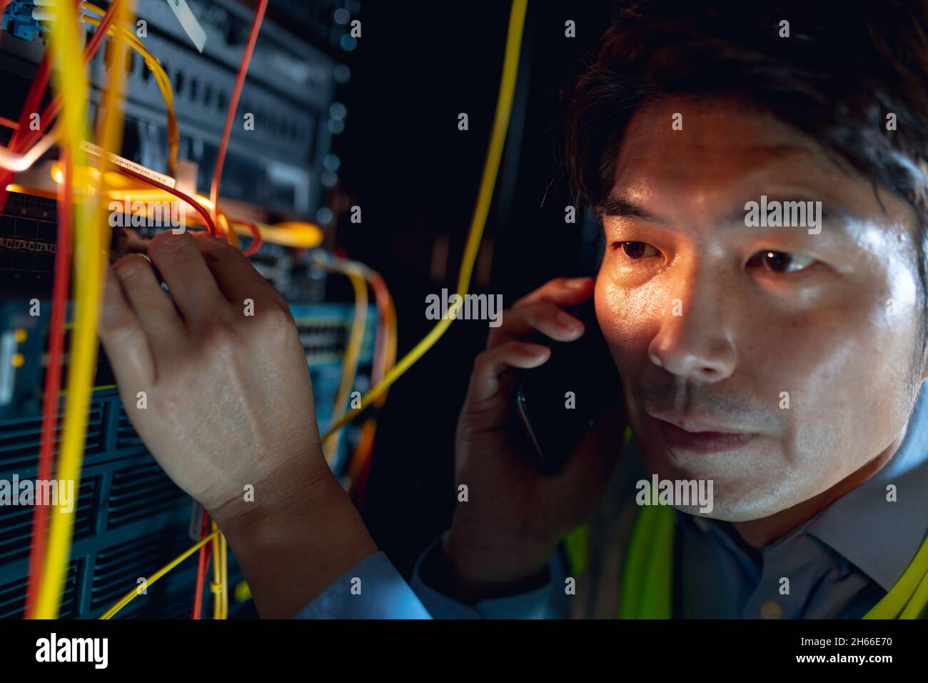 Close up of asian male engineer talking on smartphone while inspecting ...