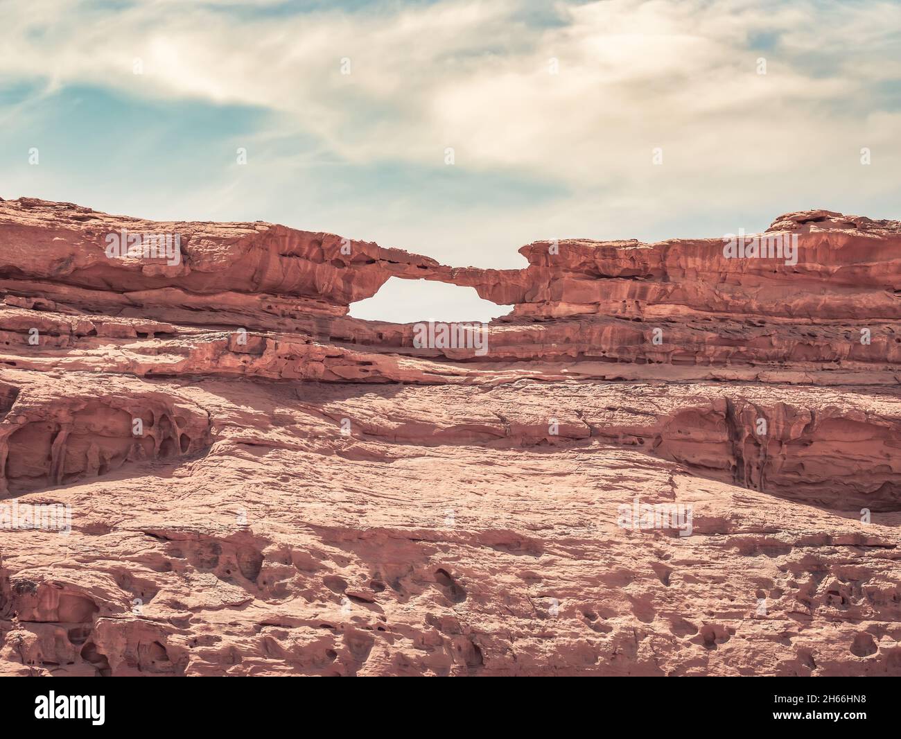 A high natural rock bridge in Wadi Rum desert, Jordan. Dramatic desert ...
